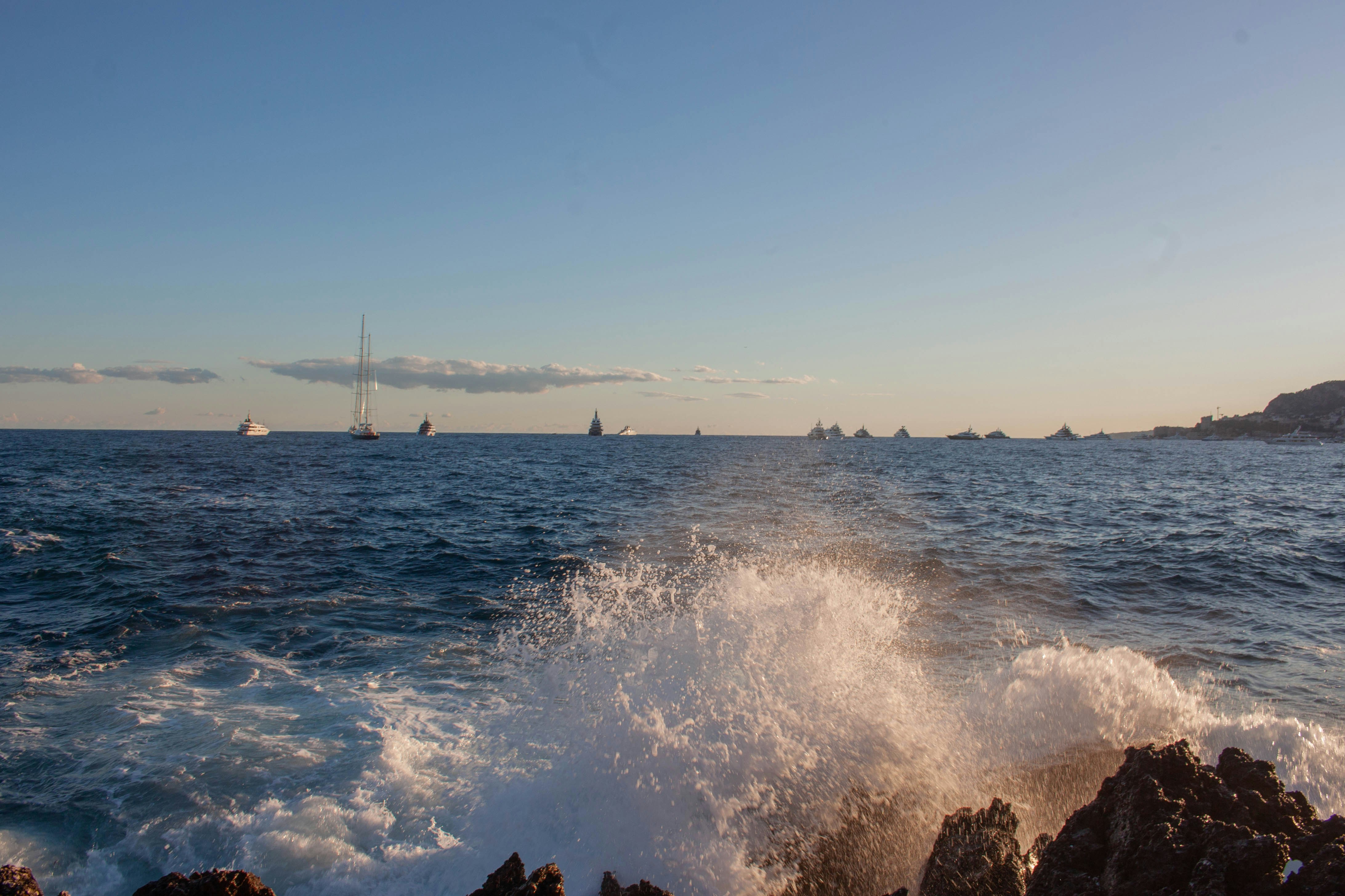Foam at the Forefront: Coastal Breakers Meet a Fleet on the Horizon