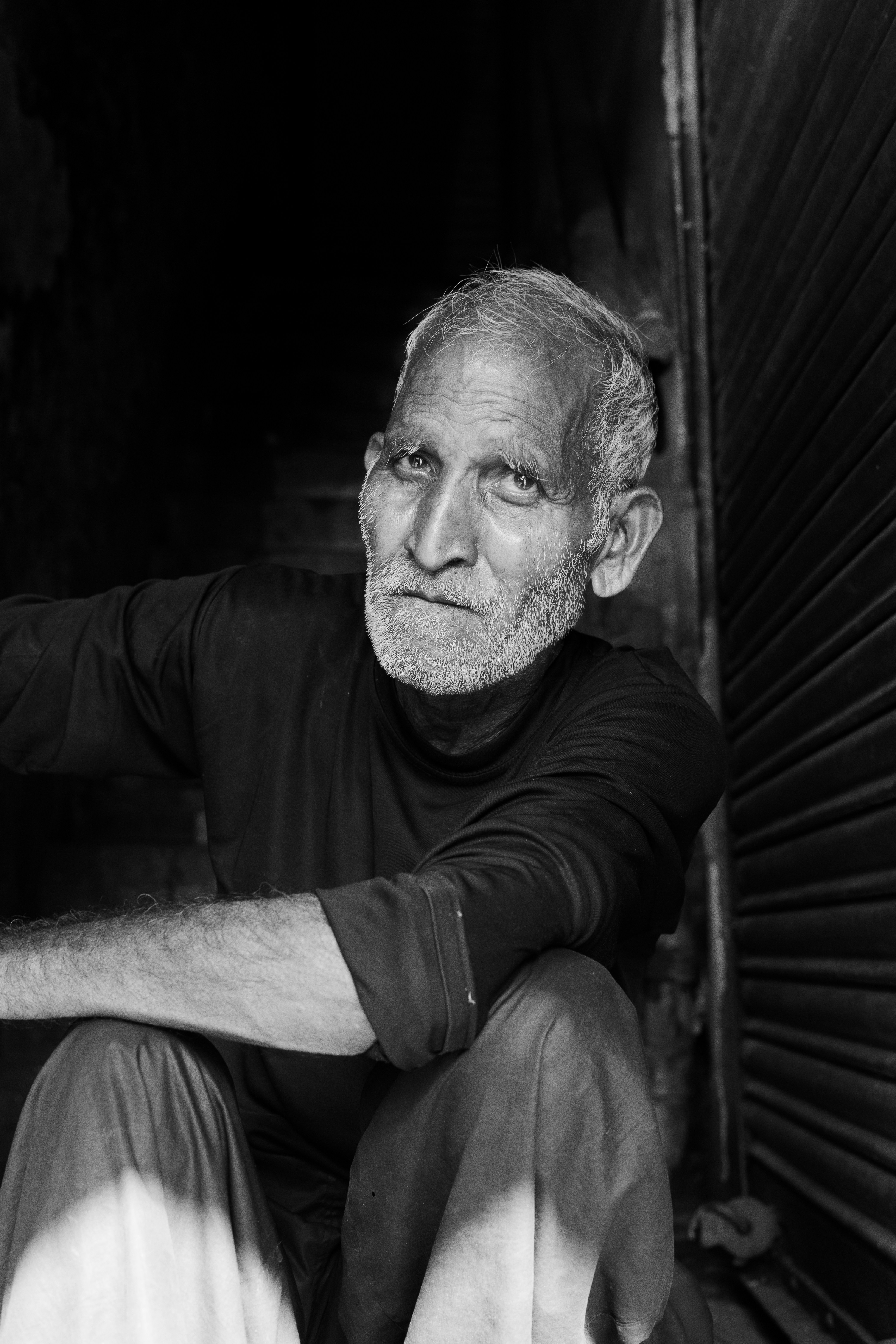 Whispers of Resilience: A Portrait in Shadows
