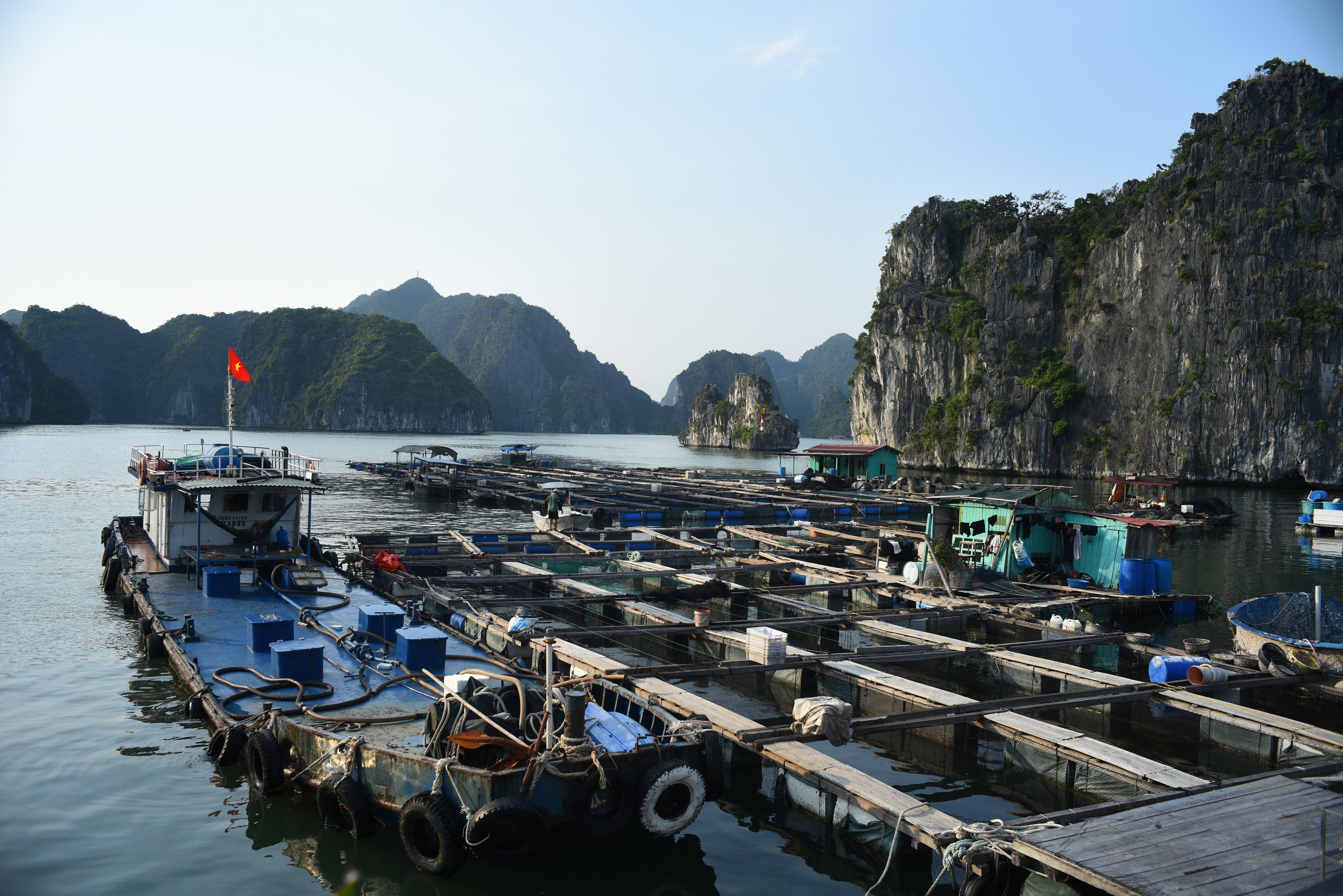 Floating village with karst formations in the background