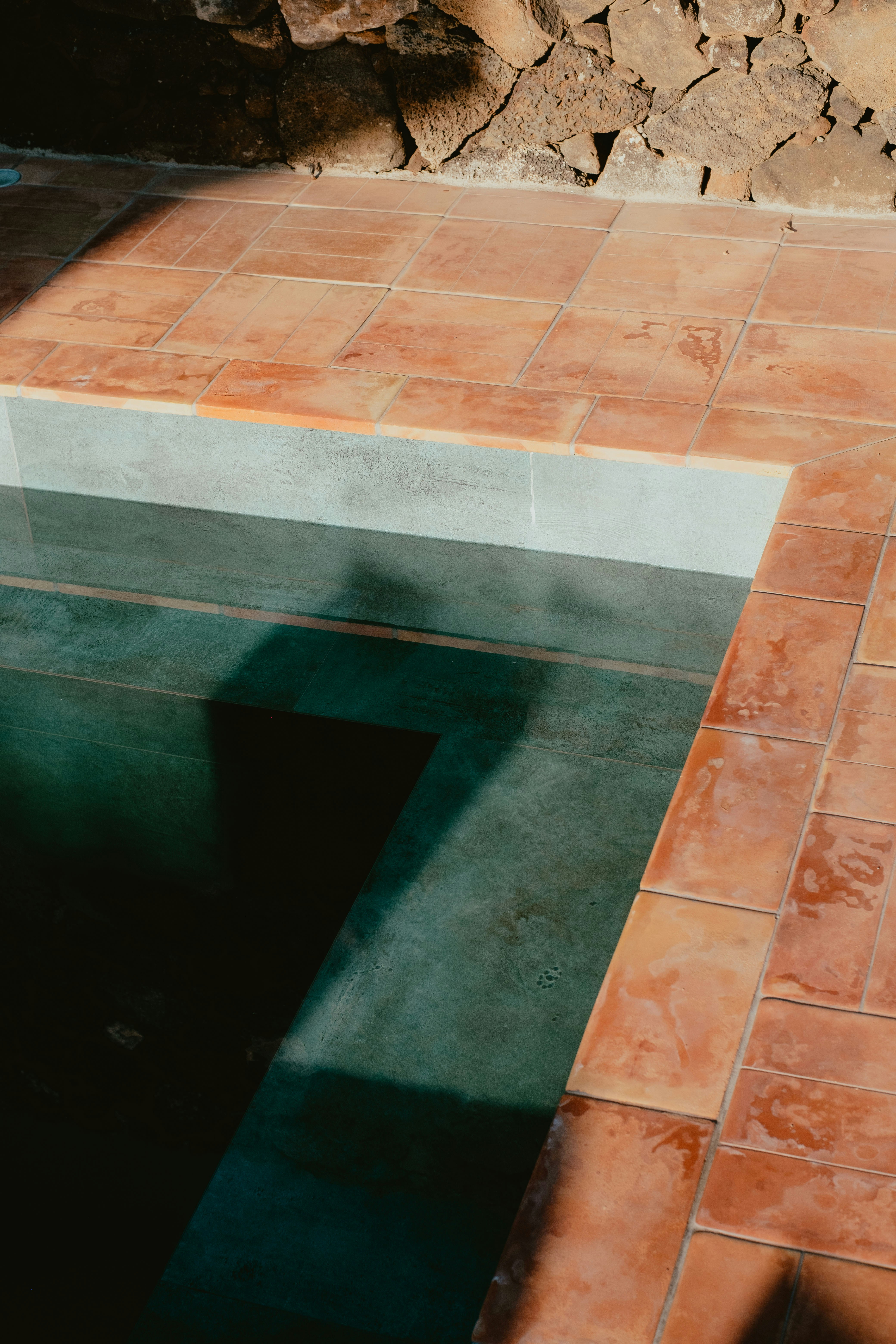 Terracotta tiled edge of a swimming pool