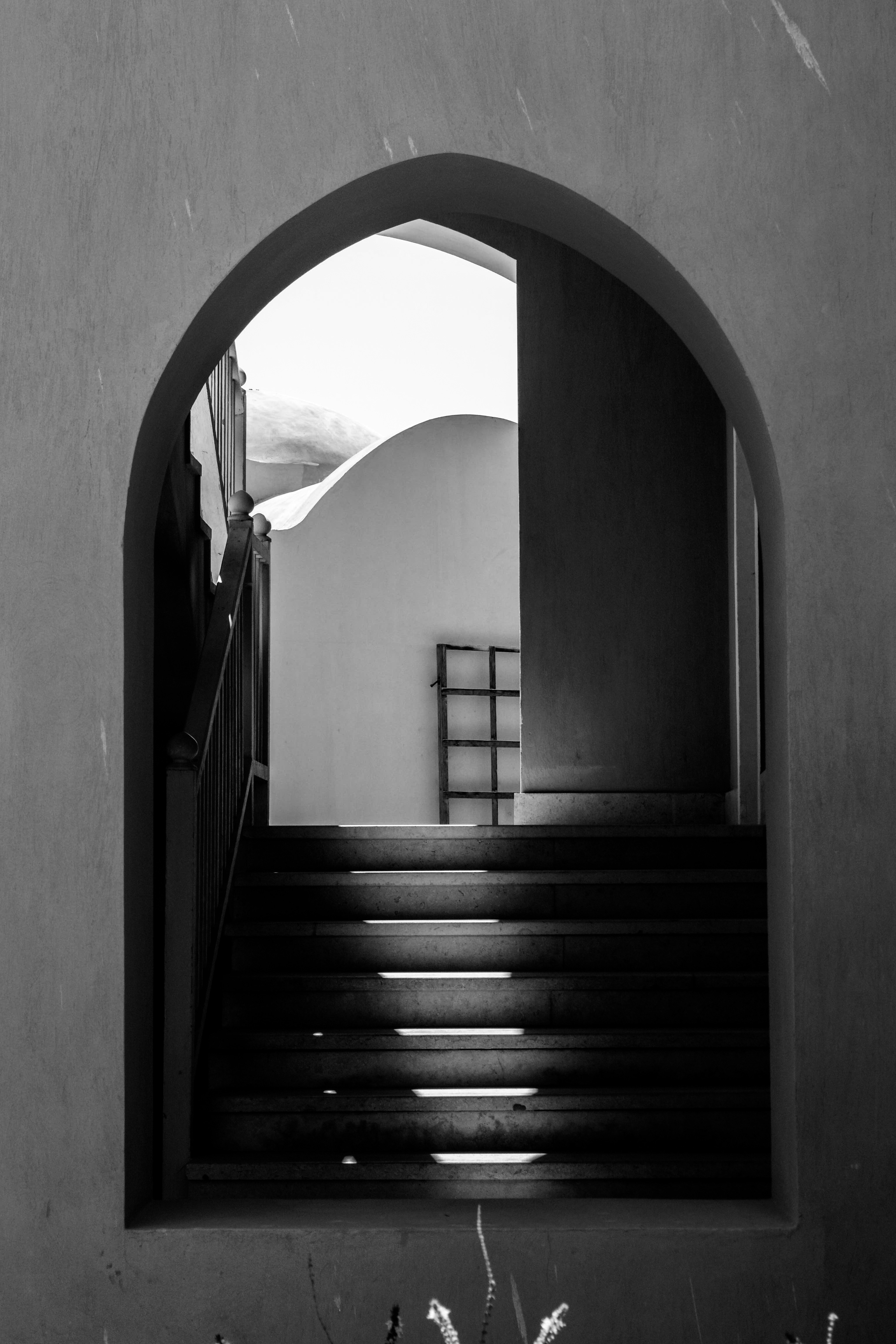 Archway leading to a staircase with light patterns