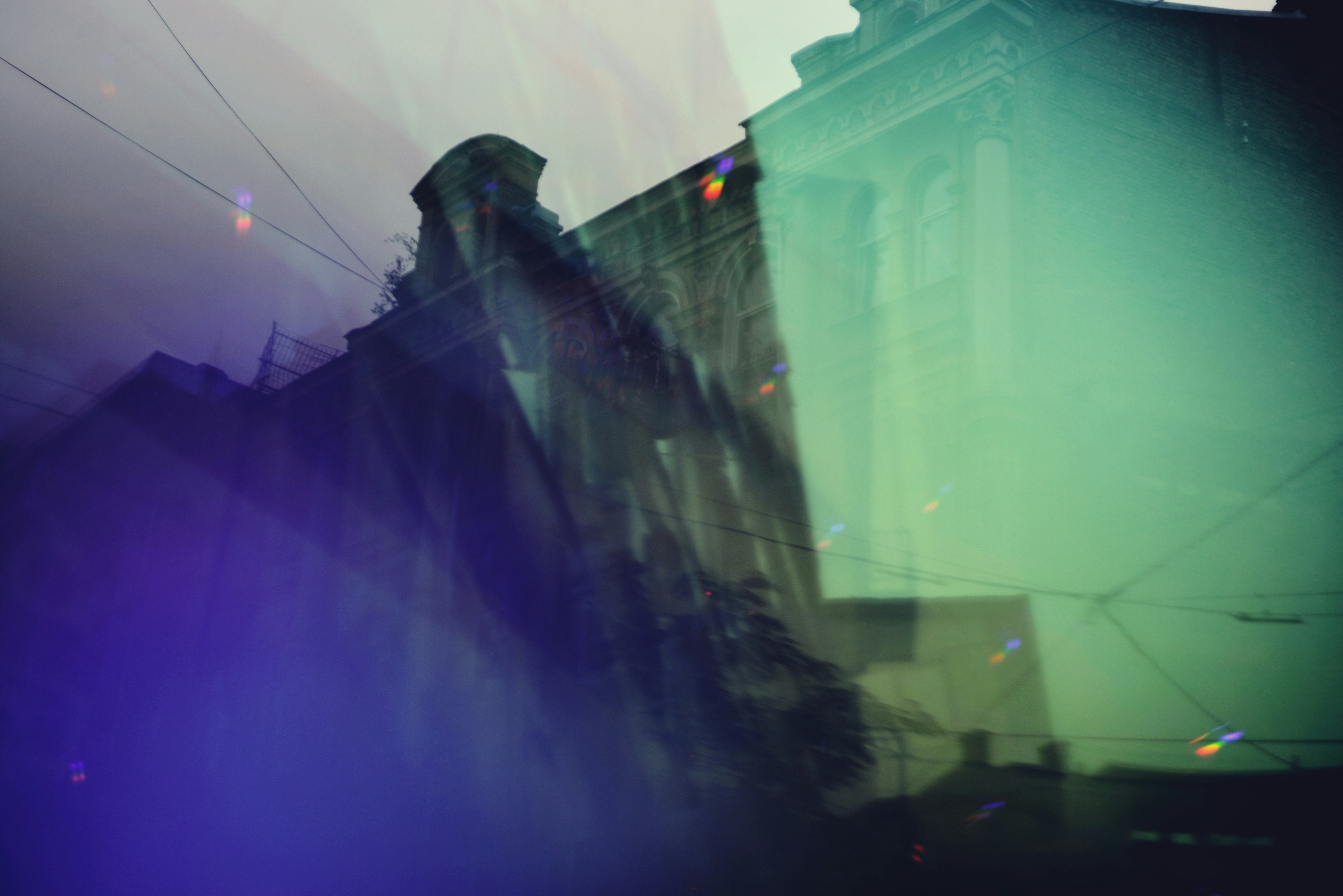 Neon Veil Over a City Façade: A Blur of Color and Shadow