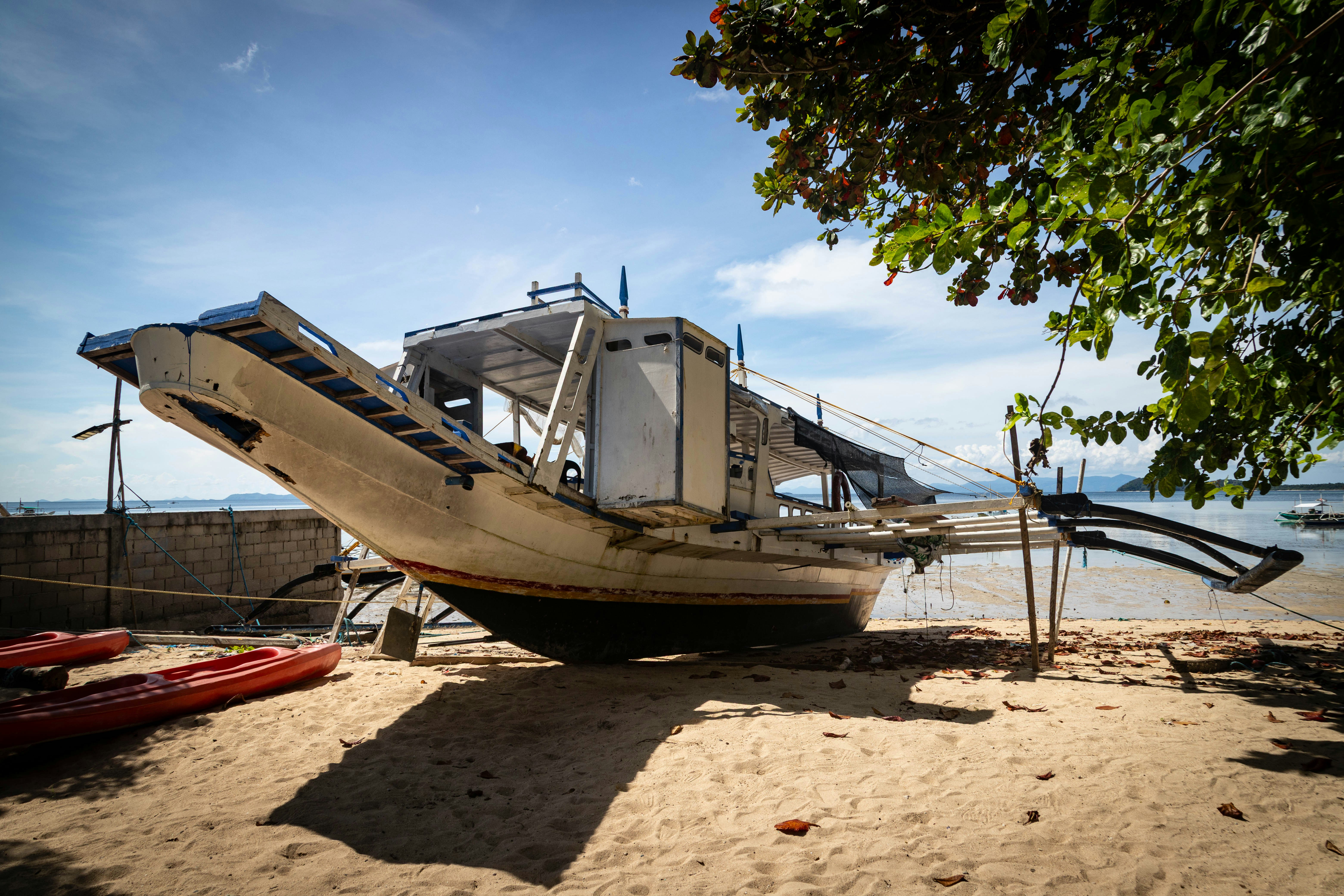 Sunlit Outrigger on the Quiet Shore: A Boat at Rest