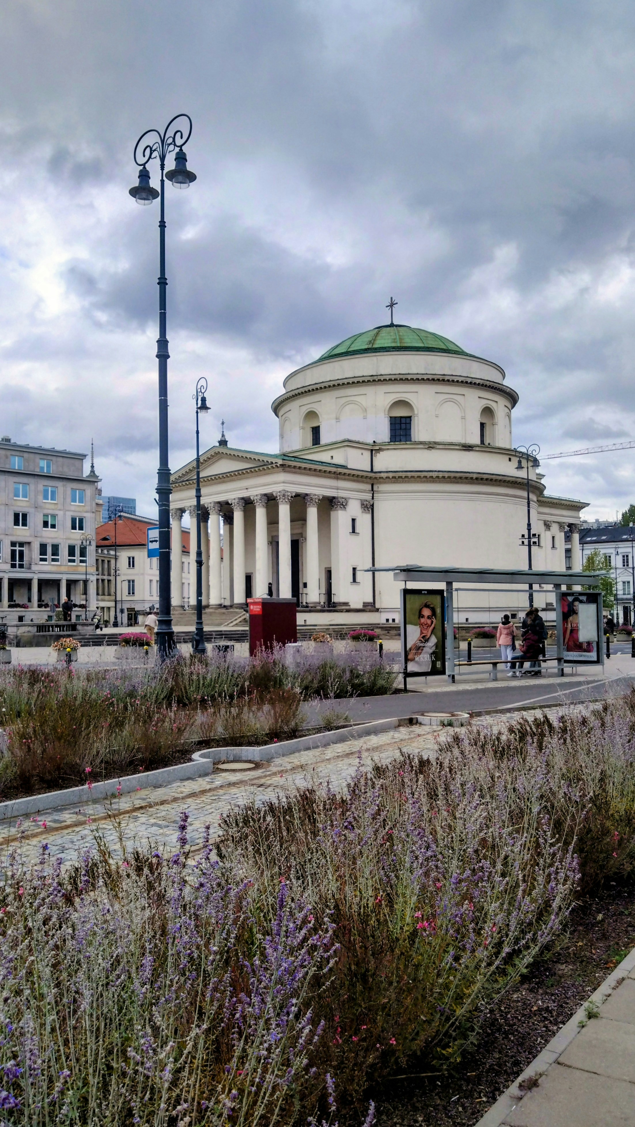A grand building with classical columns and a green dome.