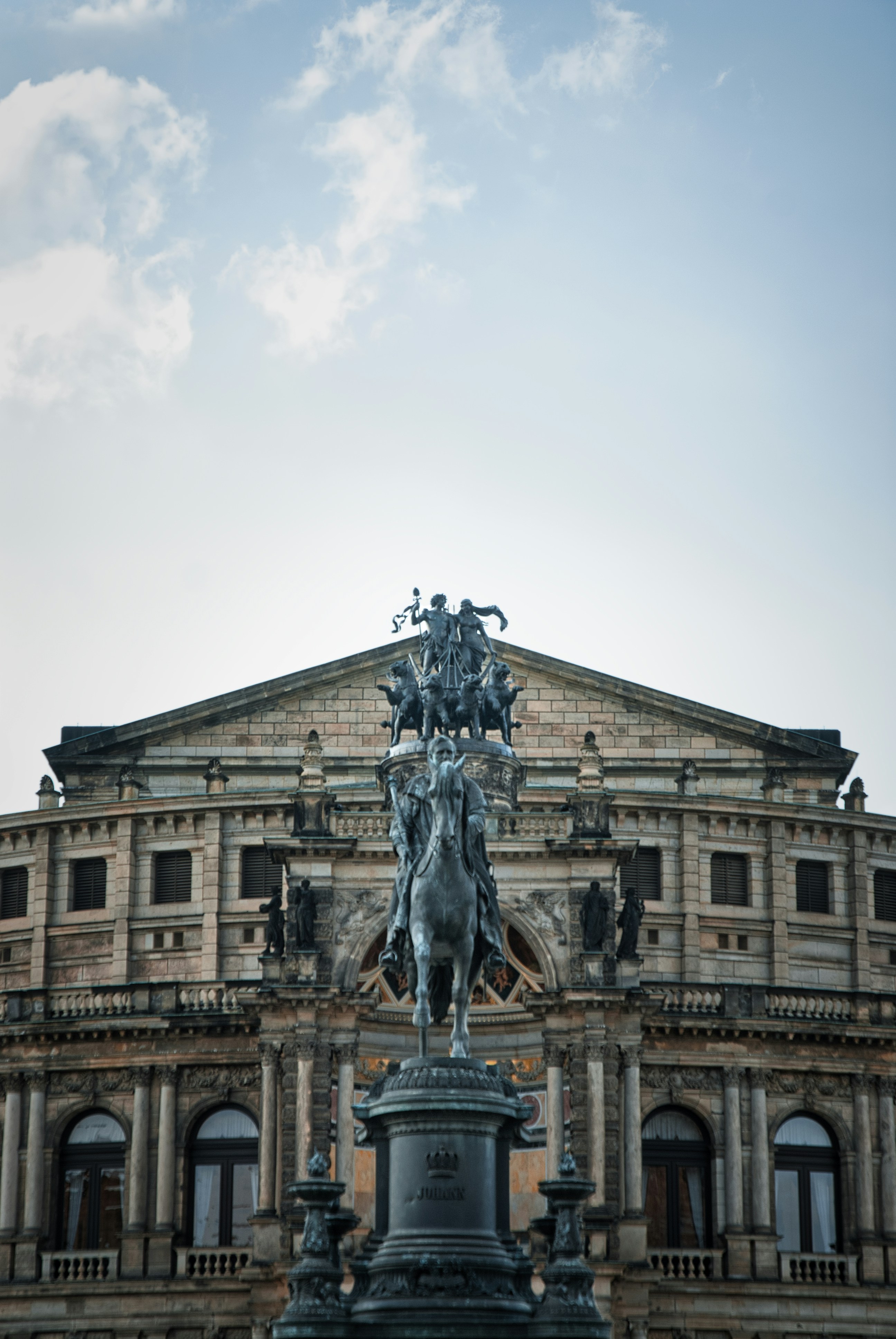 Equestrian statue in front of ornate classical building