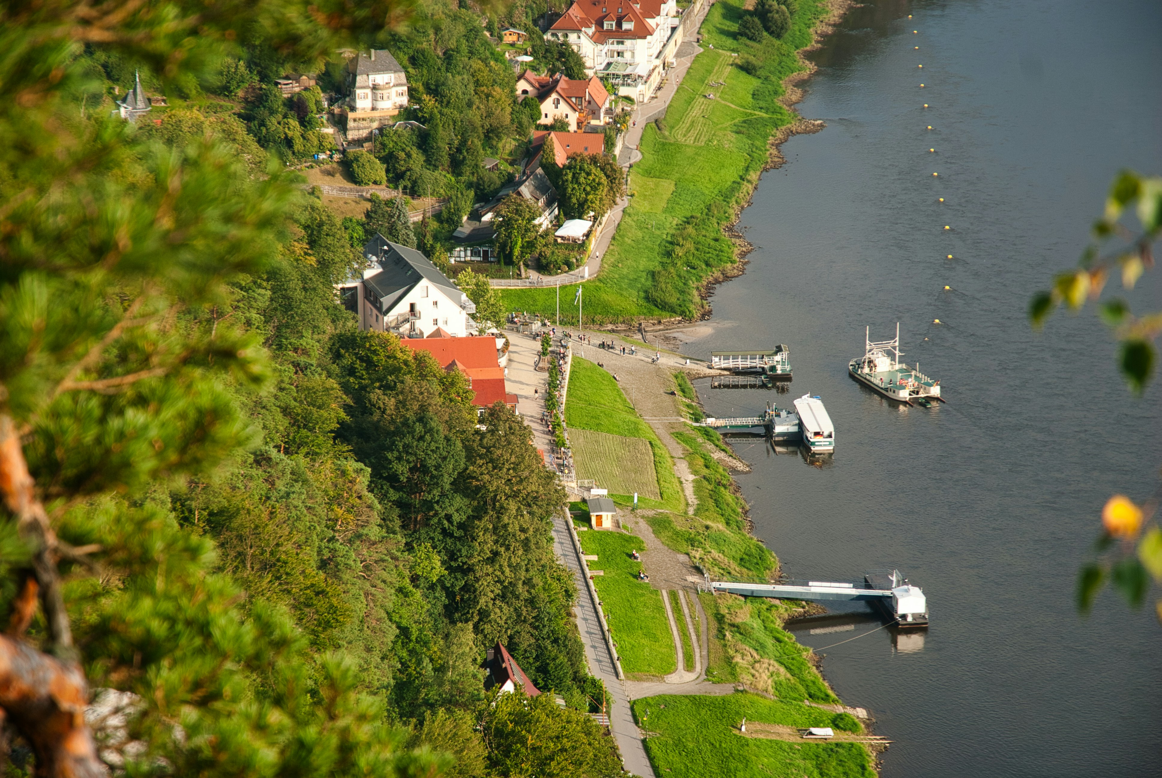 Riverfront town with boats docked along the bank.