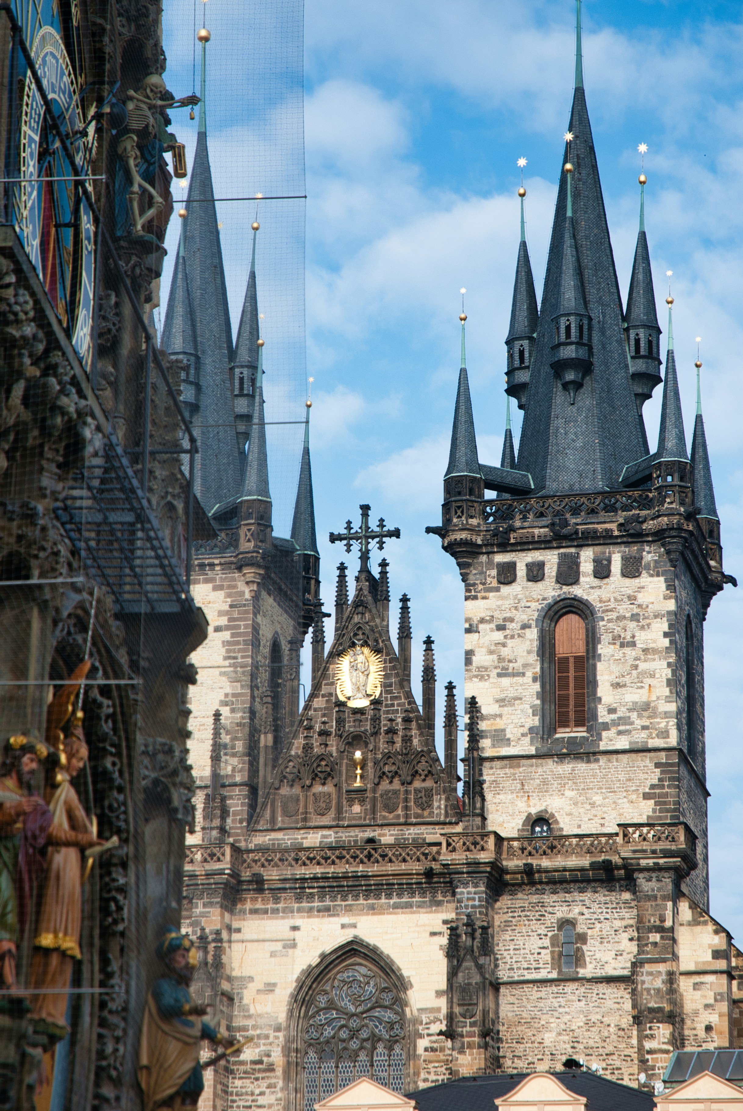 Gothic towers against a cloudy blue sky