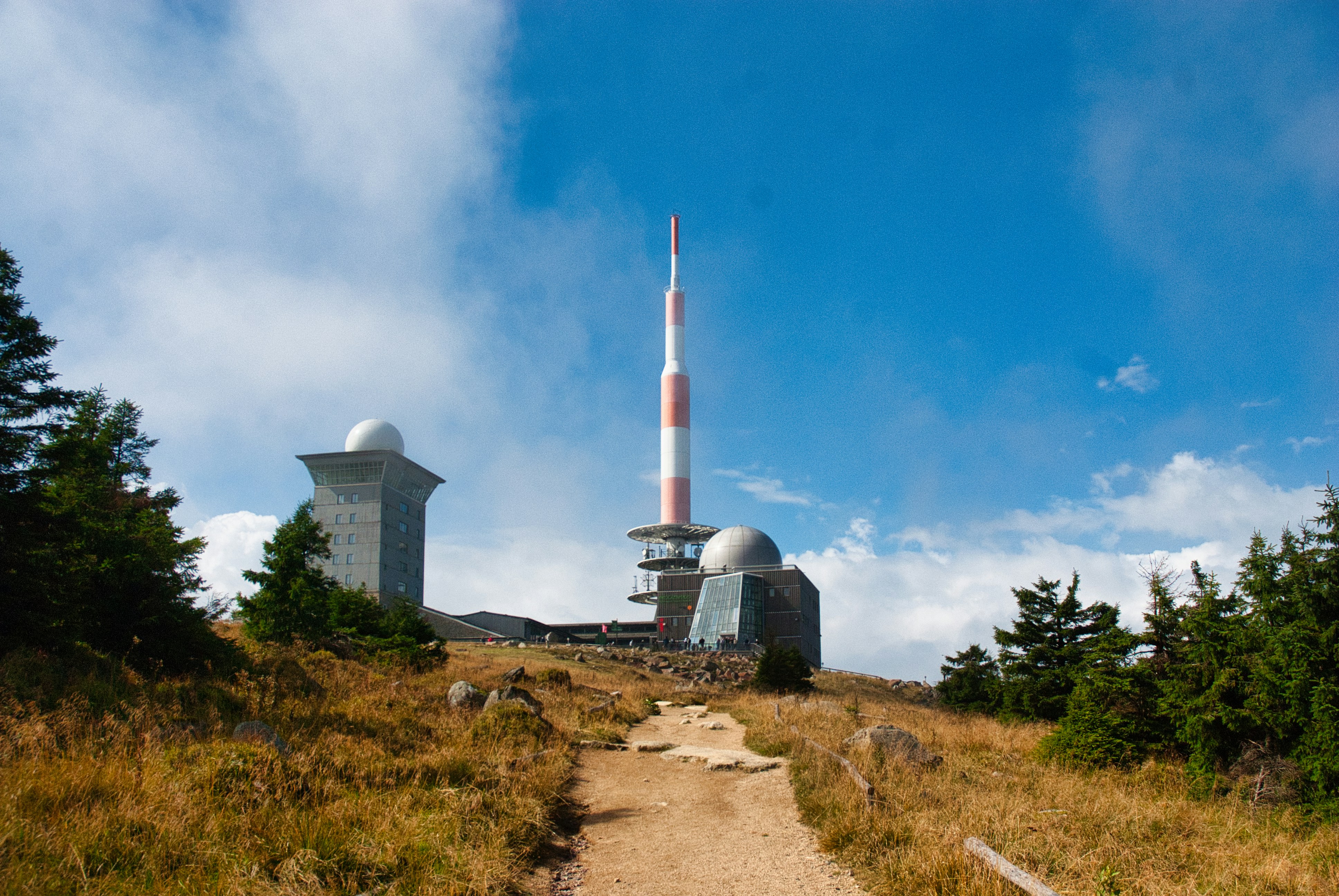 Signal Summit: The Striped Tower Standing Guard Over a Weathered Hill Path