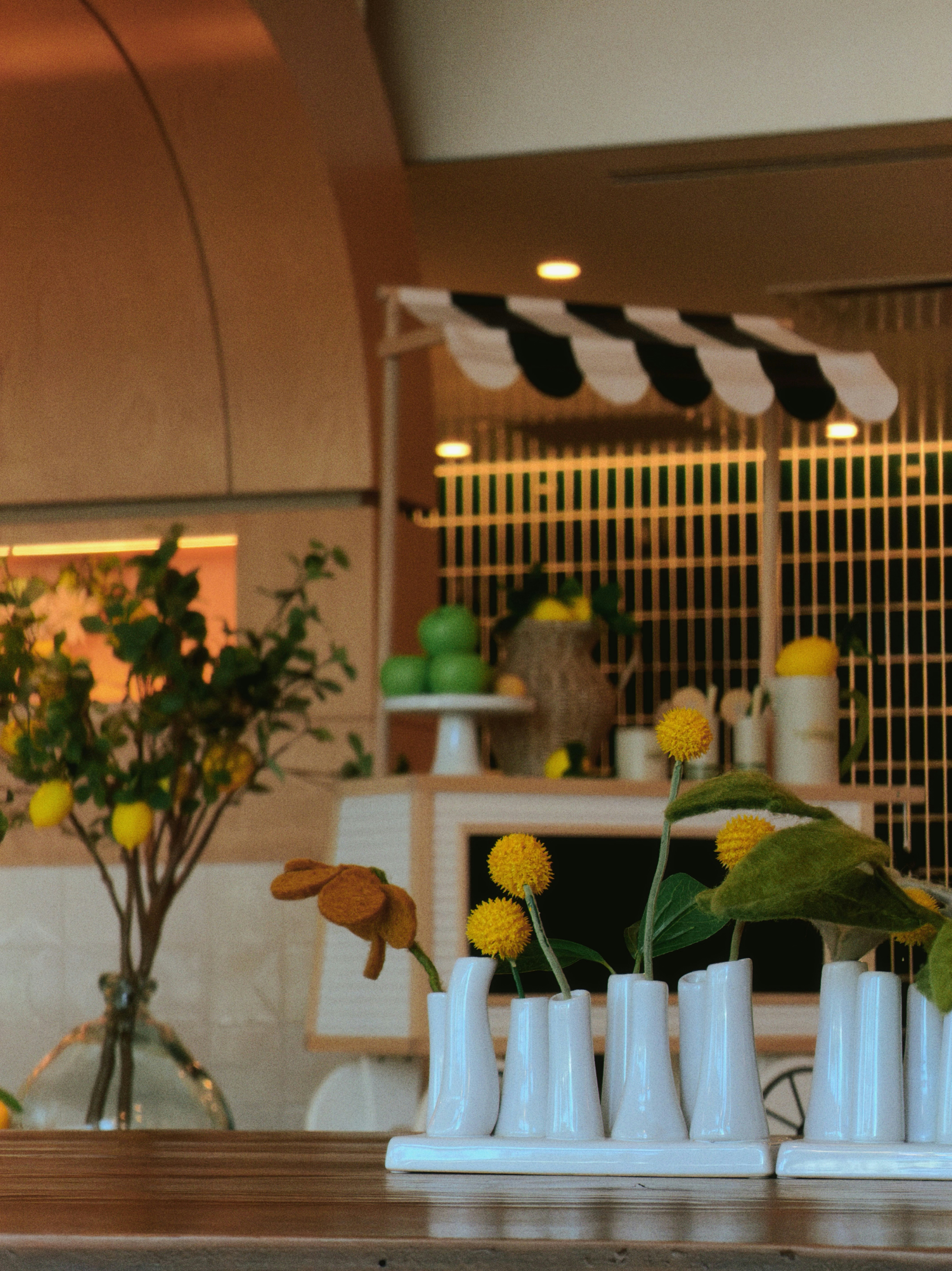 A decorative display with lemons and yellow flowers.