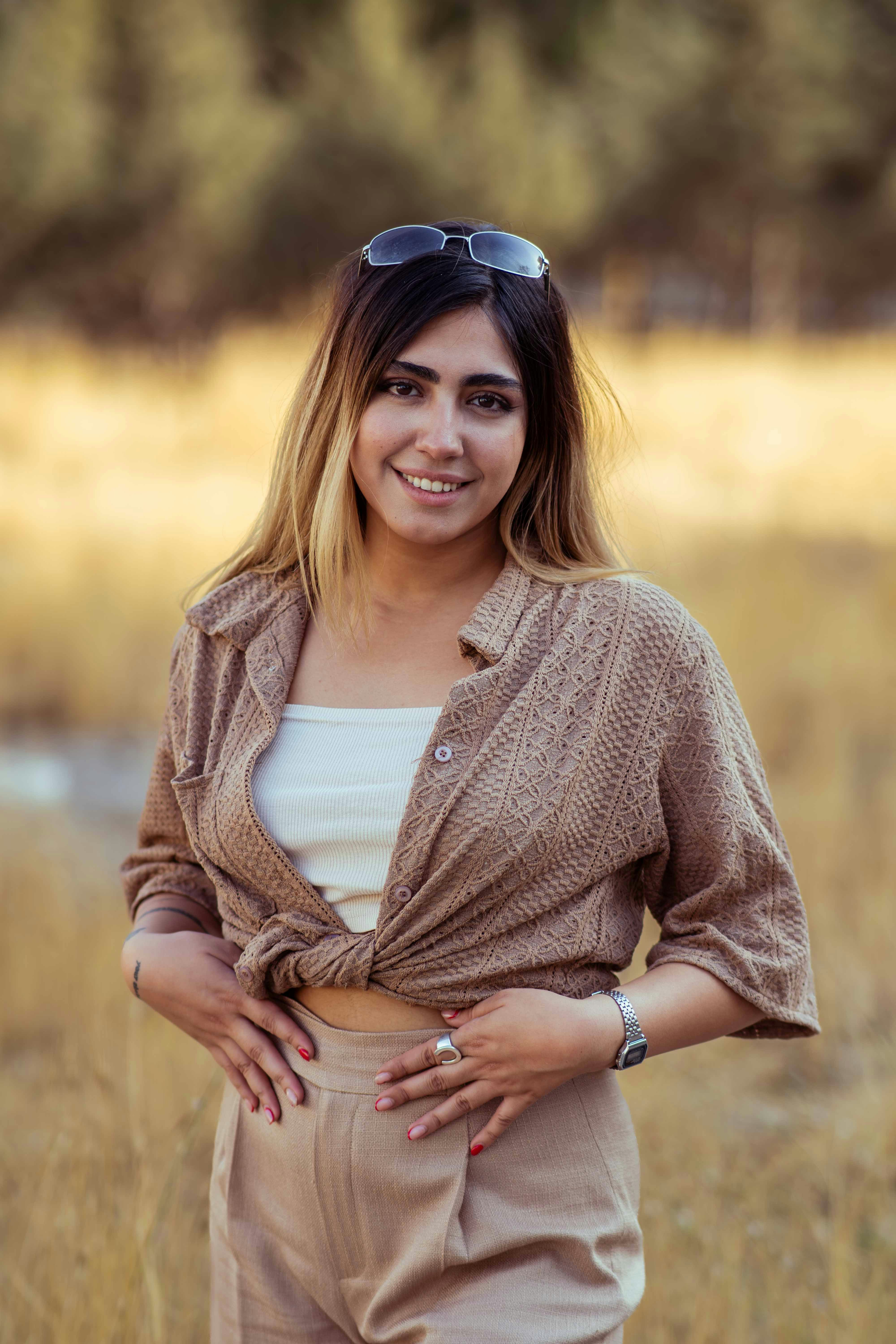 A smiling woman in casual clothing outdoors