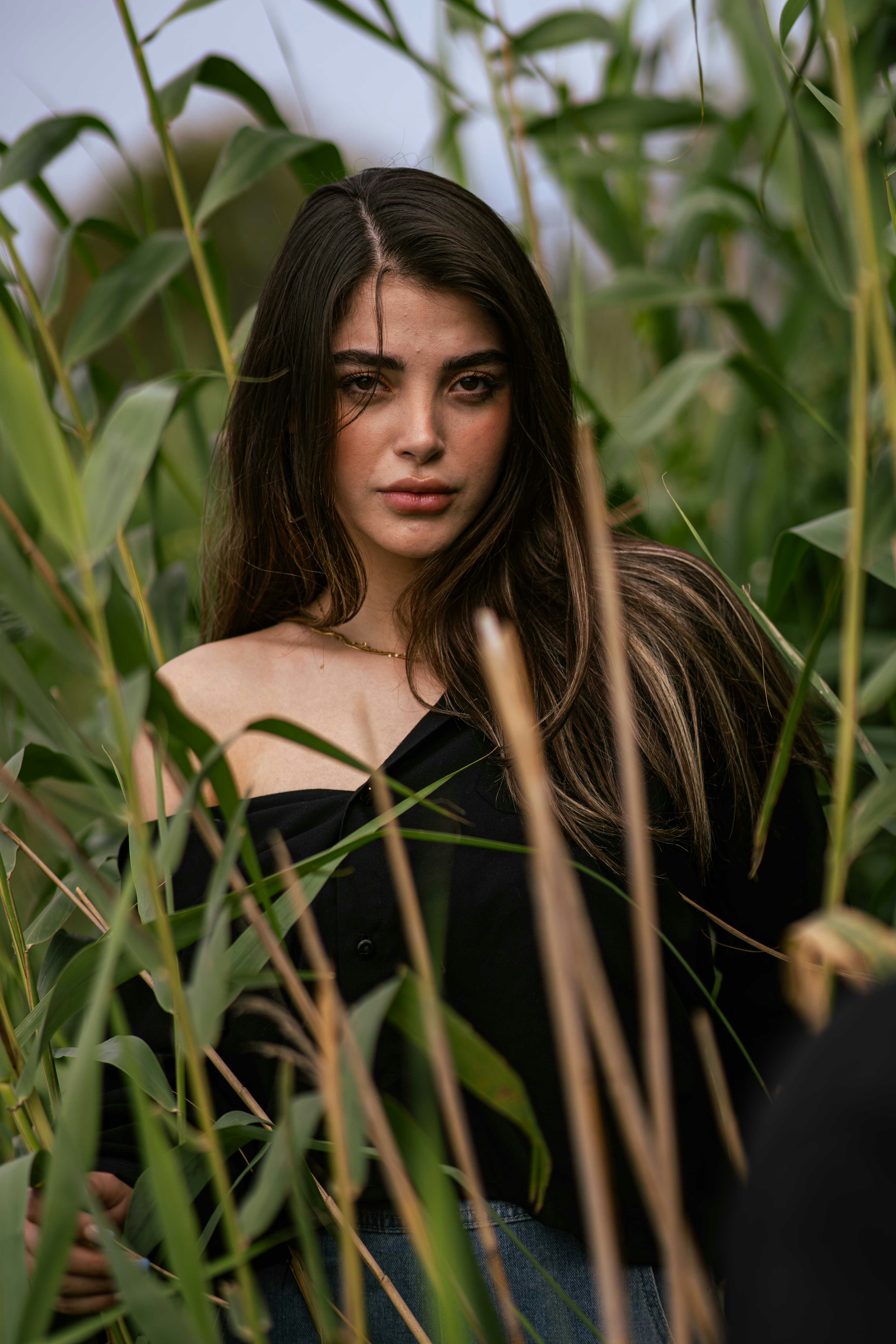 Young woman with long dark hair in a field