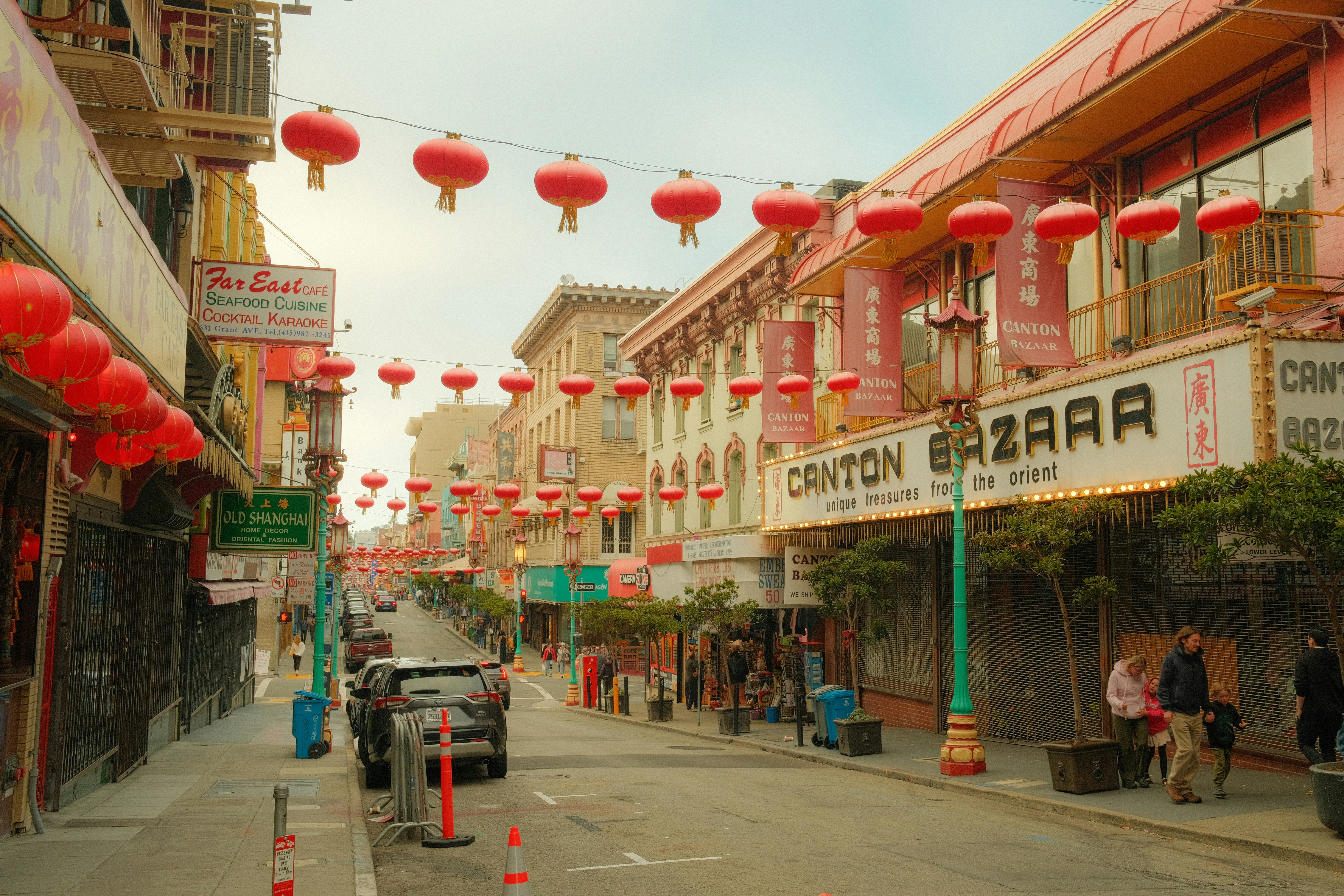 Charming street scene in Chinatown adorned with vibrant red lanterns, showcasing local shops and a bustling atmosphere.