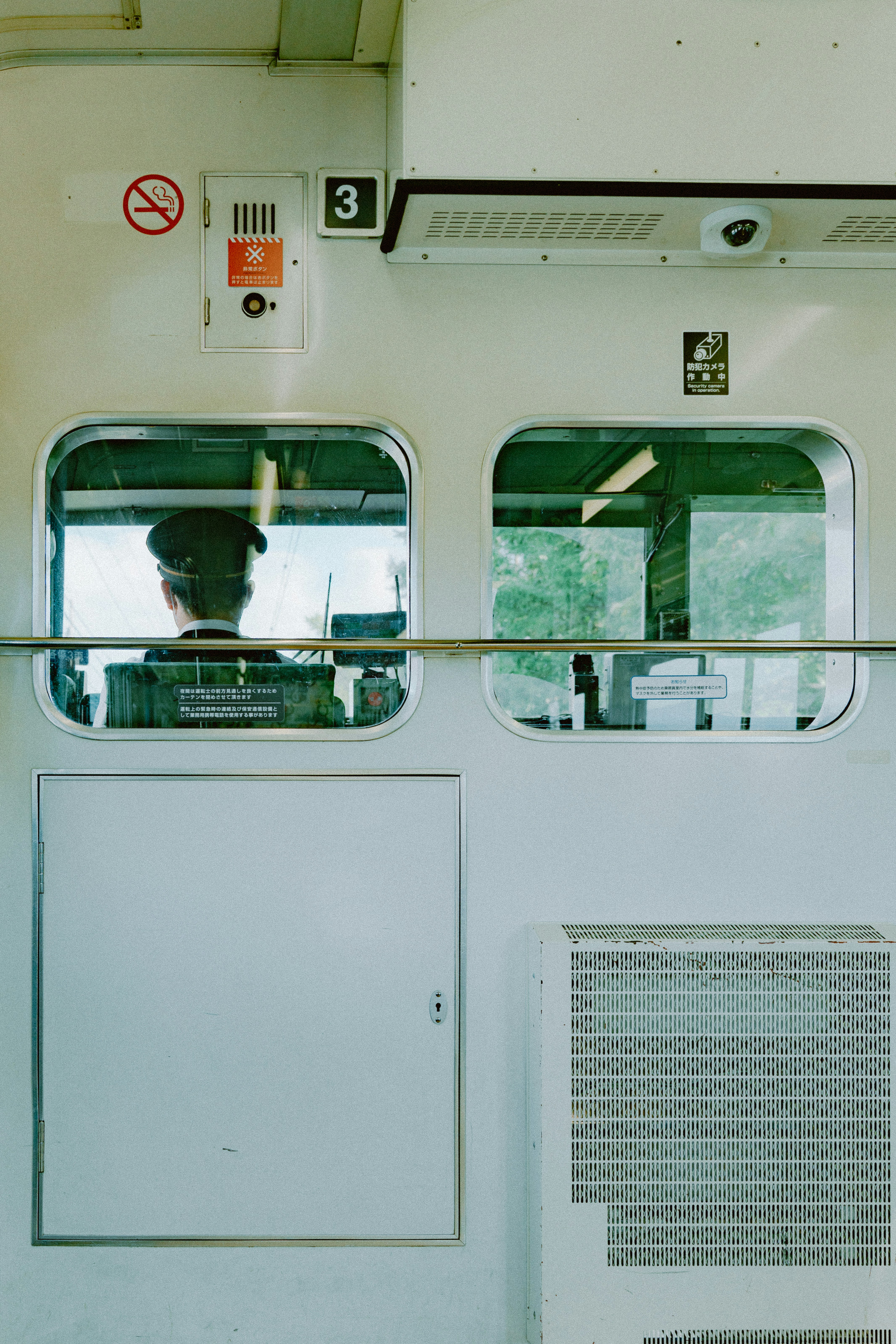 Train conductor in uniform driving the train.