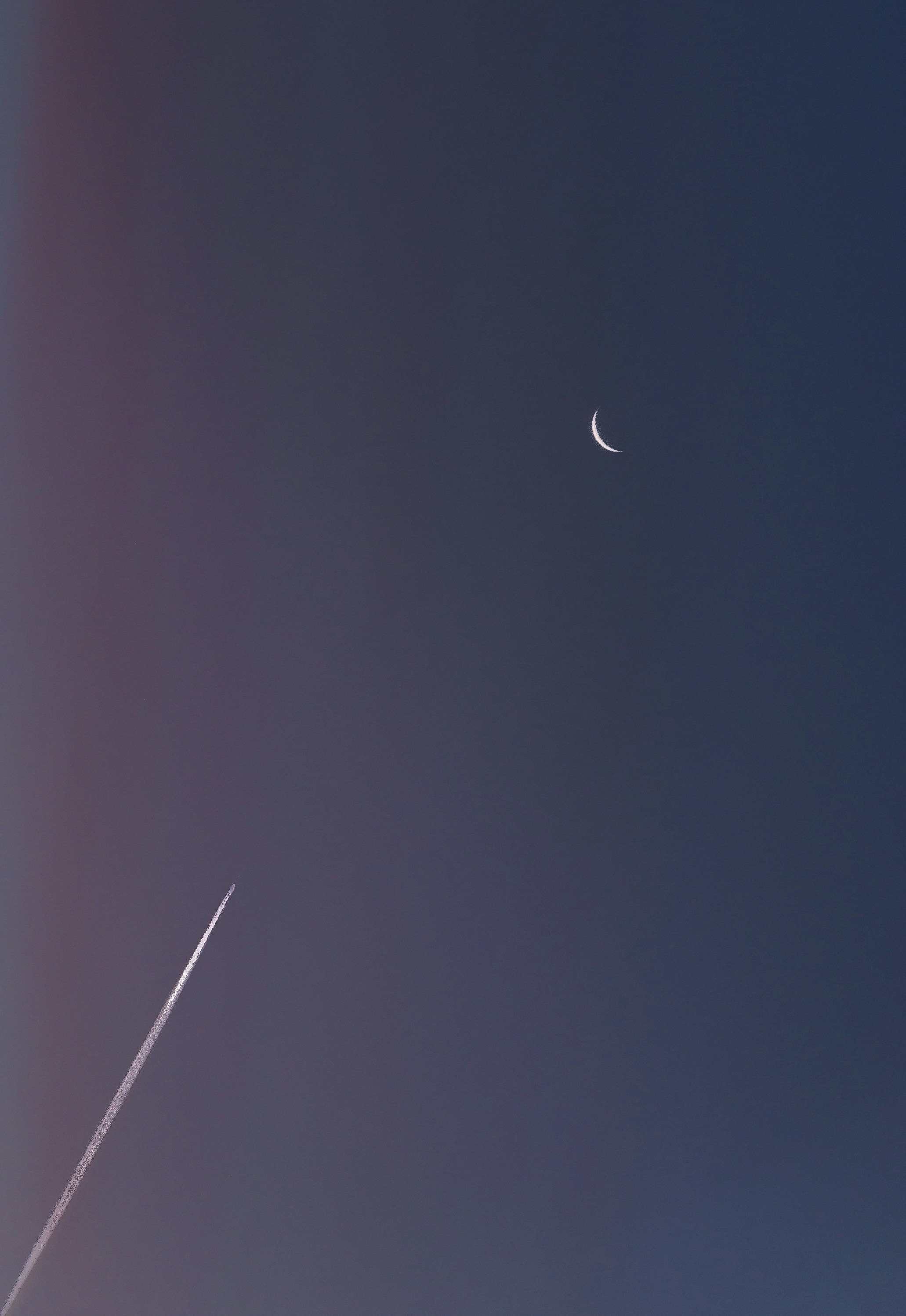 Whispers of the Sky: A Jet's Journey Beneath the Crescent Moon