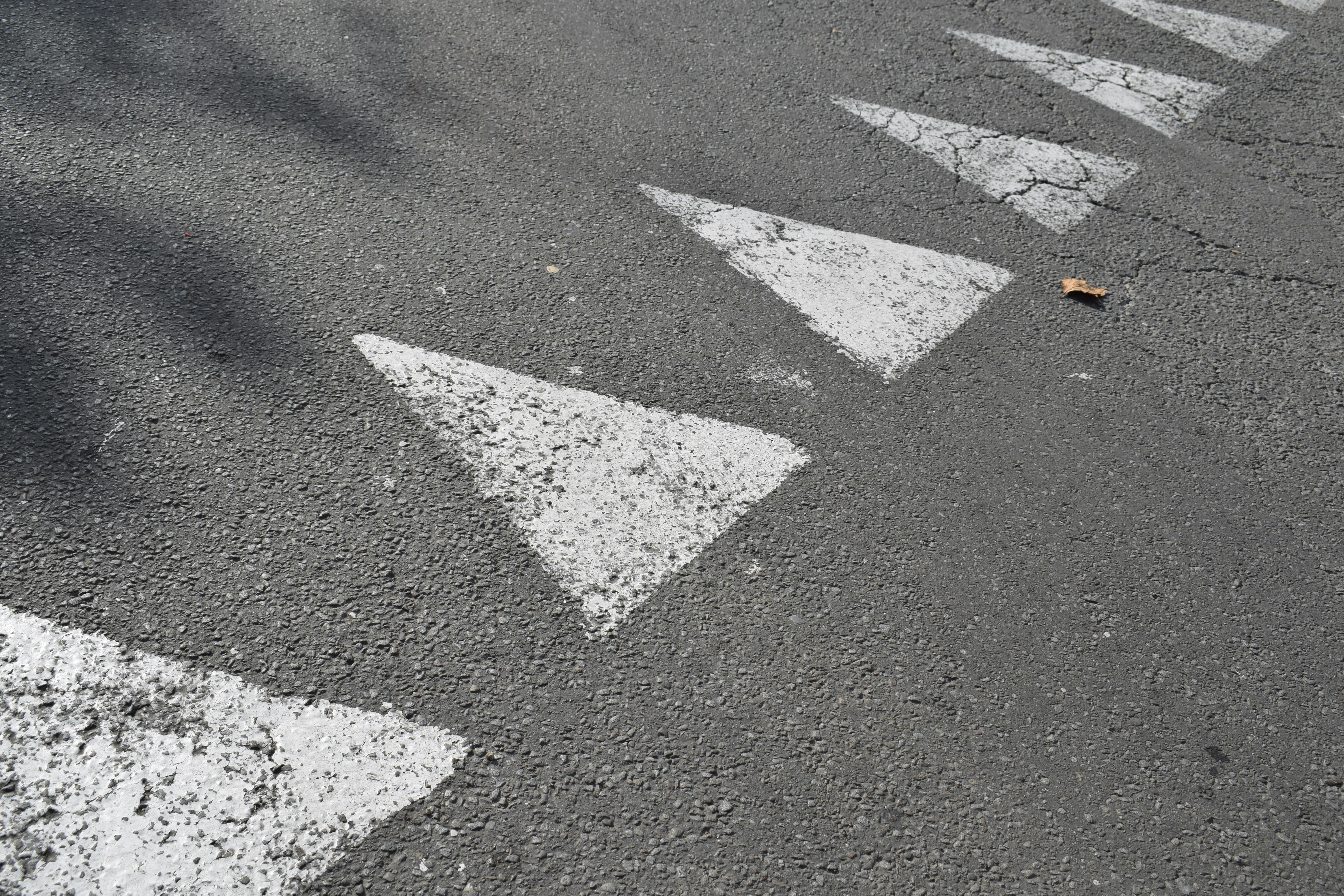 White triangles painted on asphalt road surface.