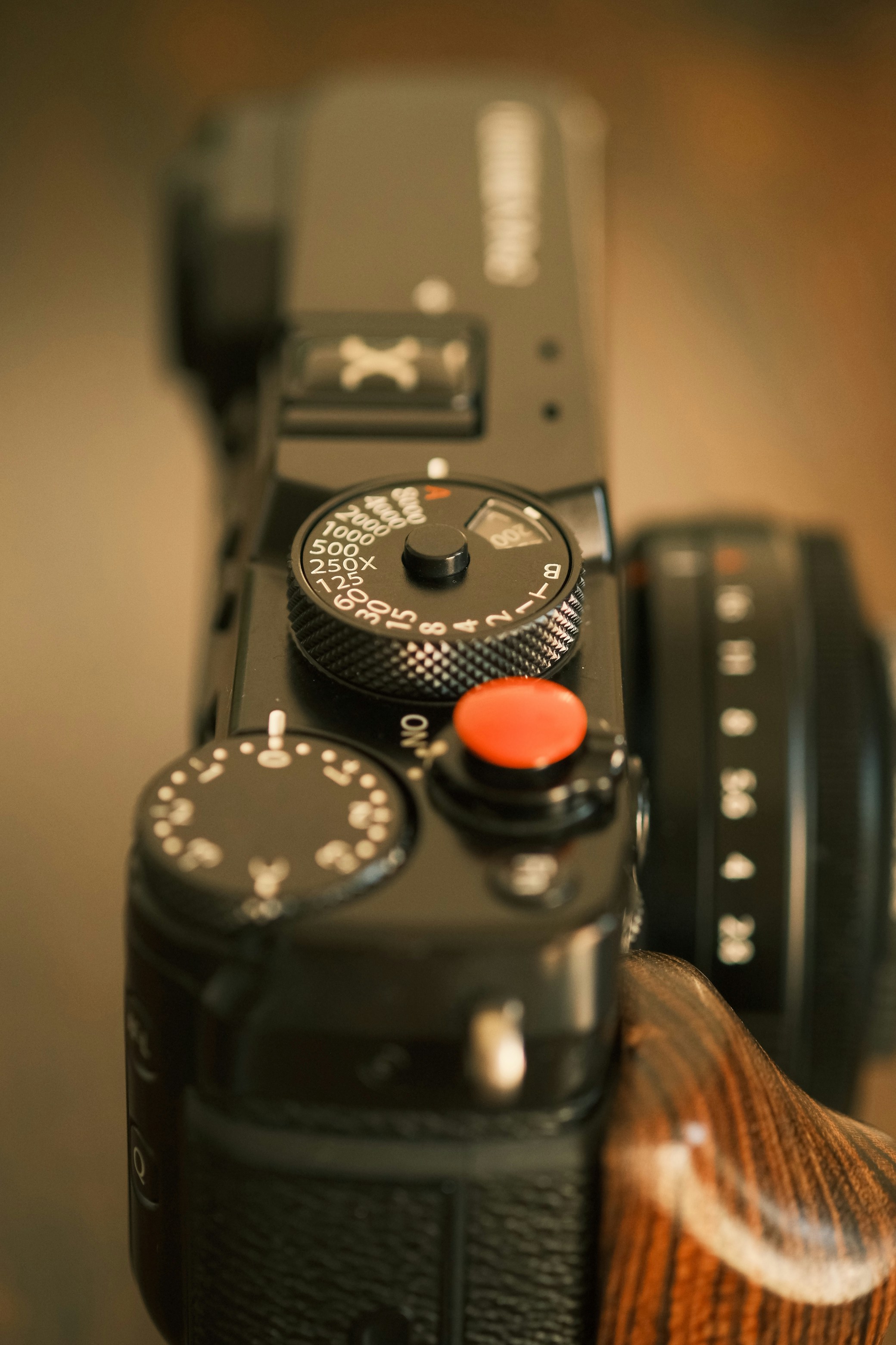 Detailed view of the top controls and dials of the Fujifilm X-S20 camera, showcasing its intricate design and functionality.