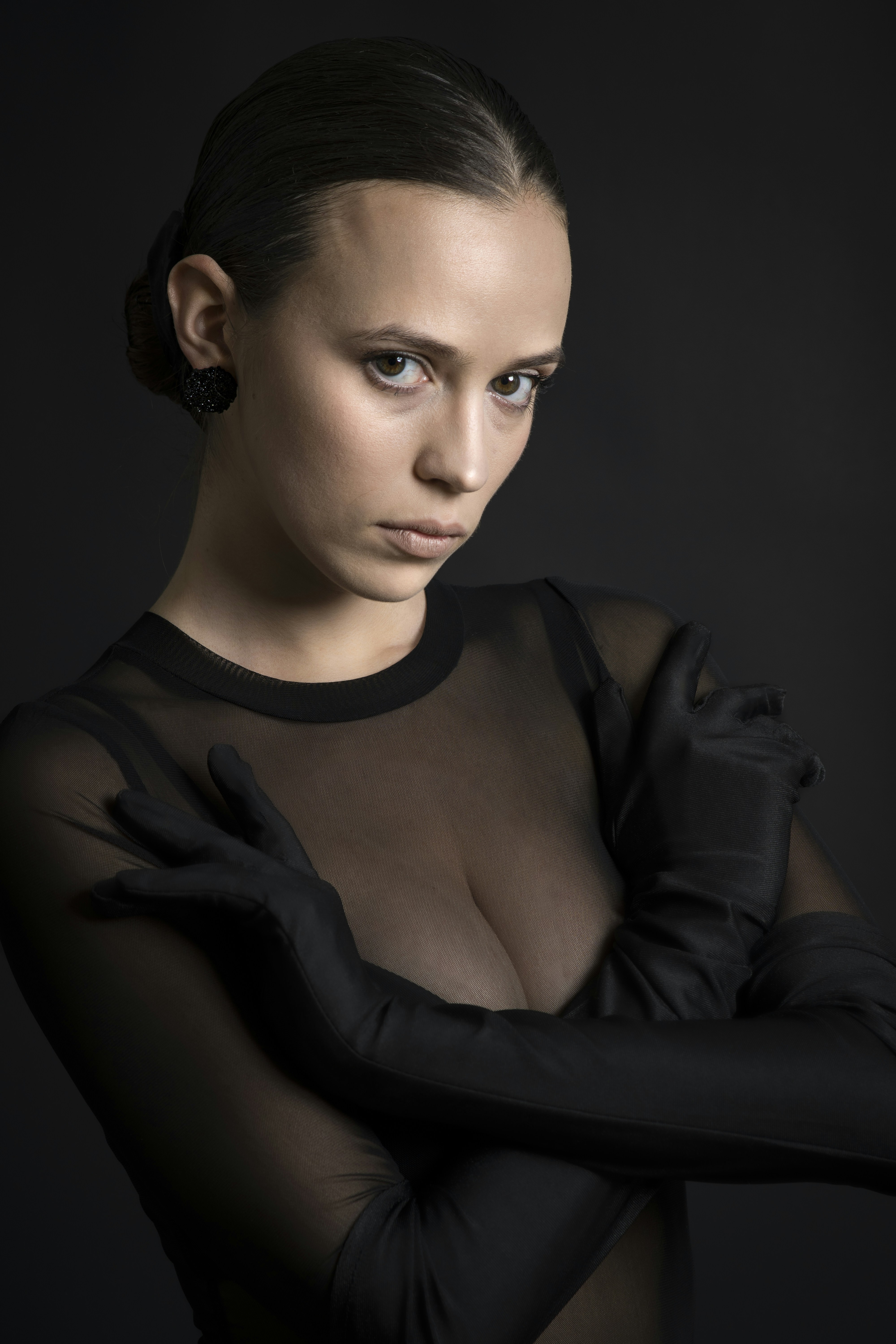 Woman in sheer black top and gloves