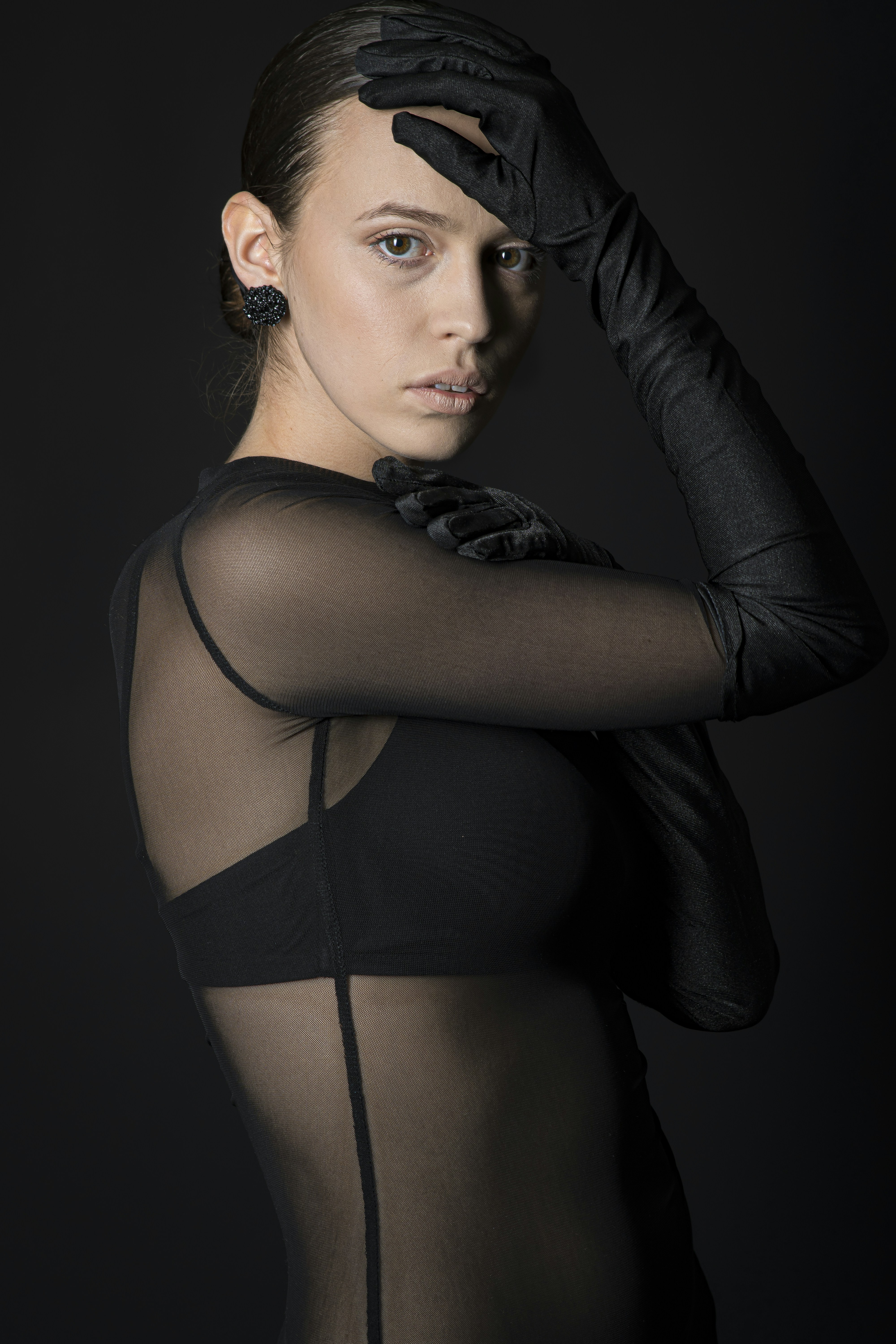 Woman in sheer black dress and gloves