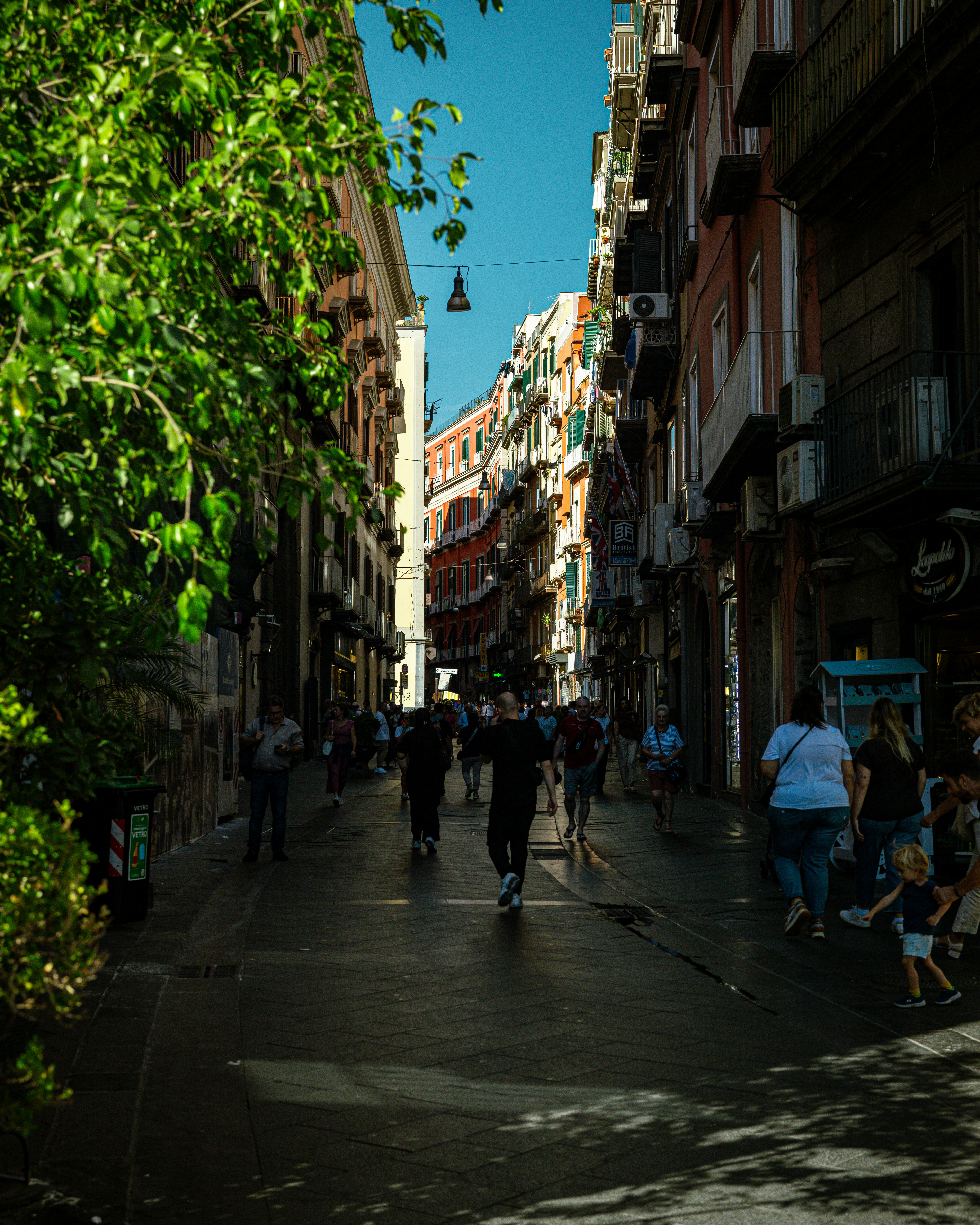 People walking down a narrow european street.