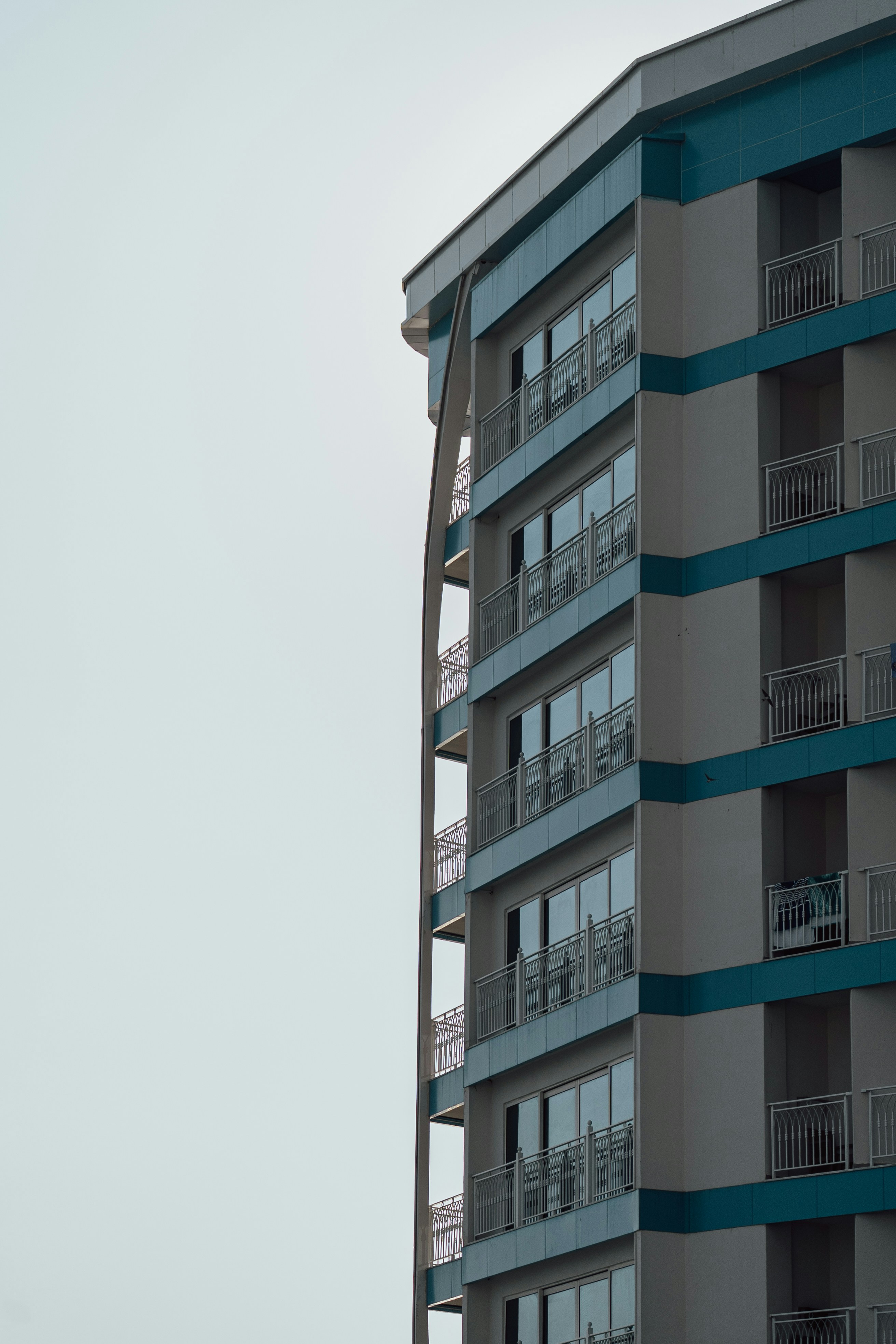 Hotel in turkey | Modern apartment building with balconies and blue accents
