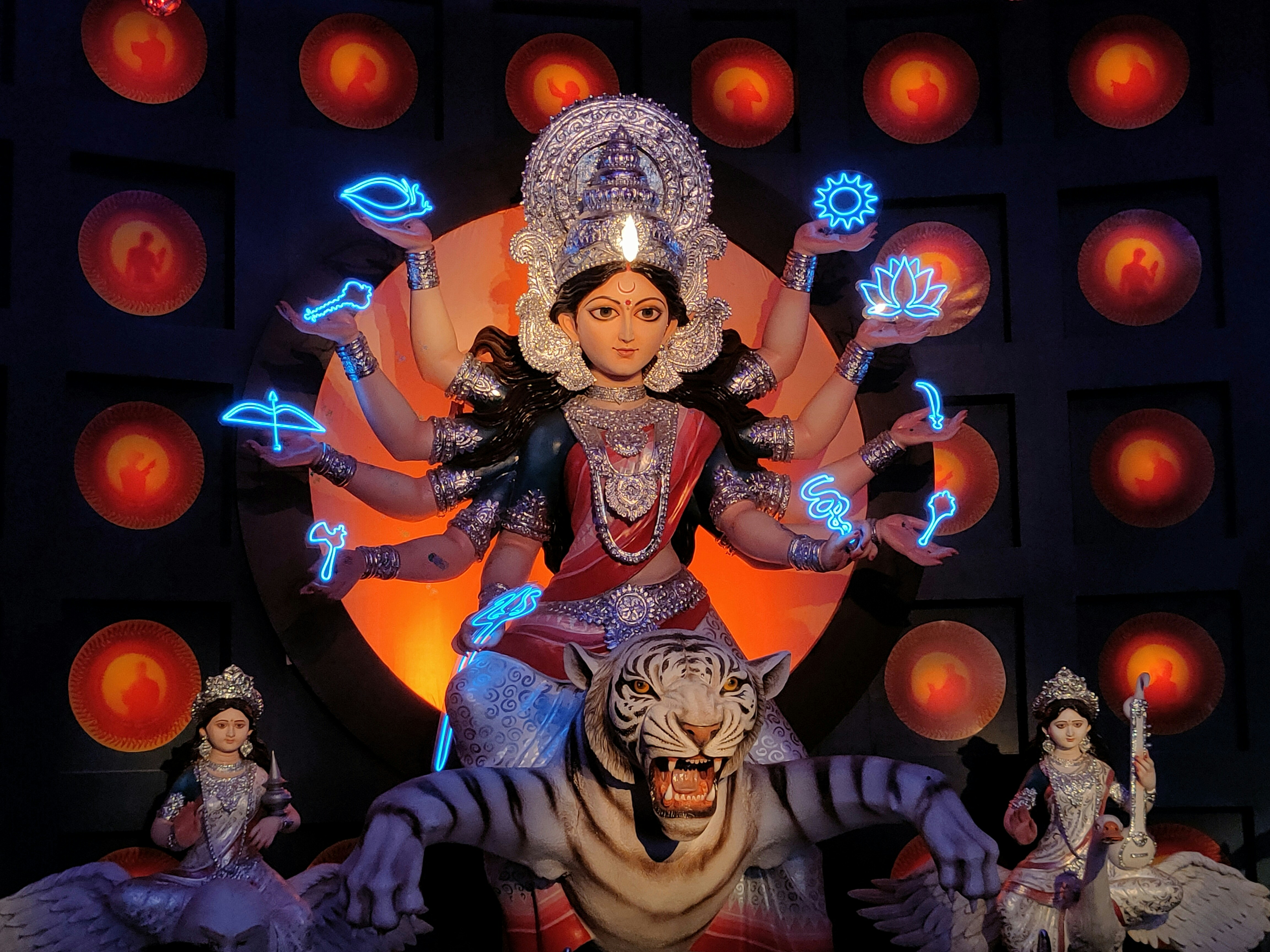 Goddess durga statue with multiple arms on tiger