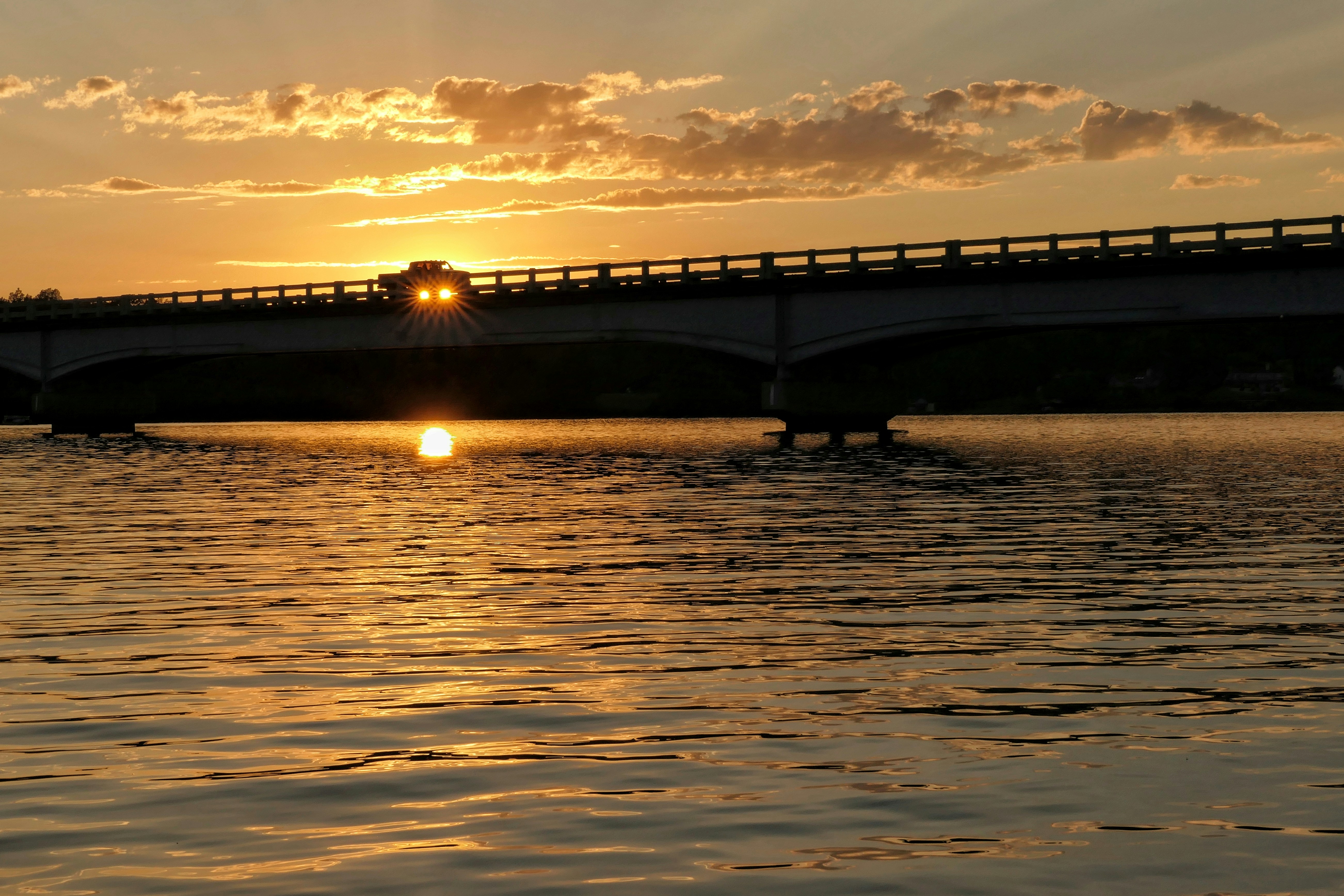bridge sunset | Sunset over a bridge with reflection on water