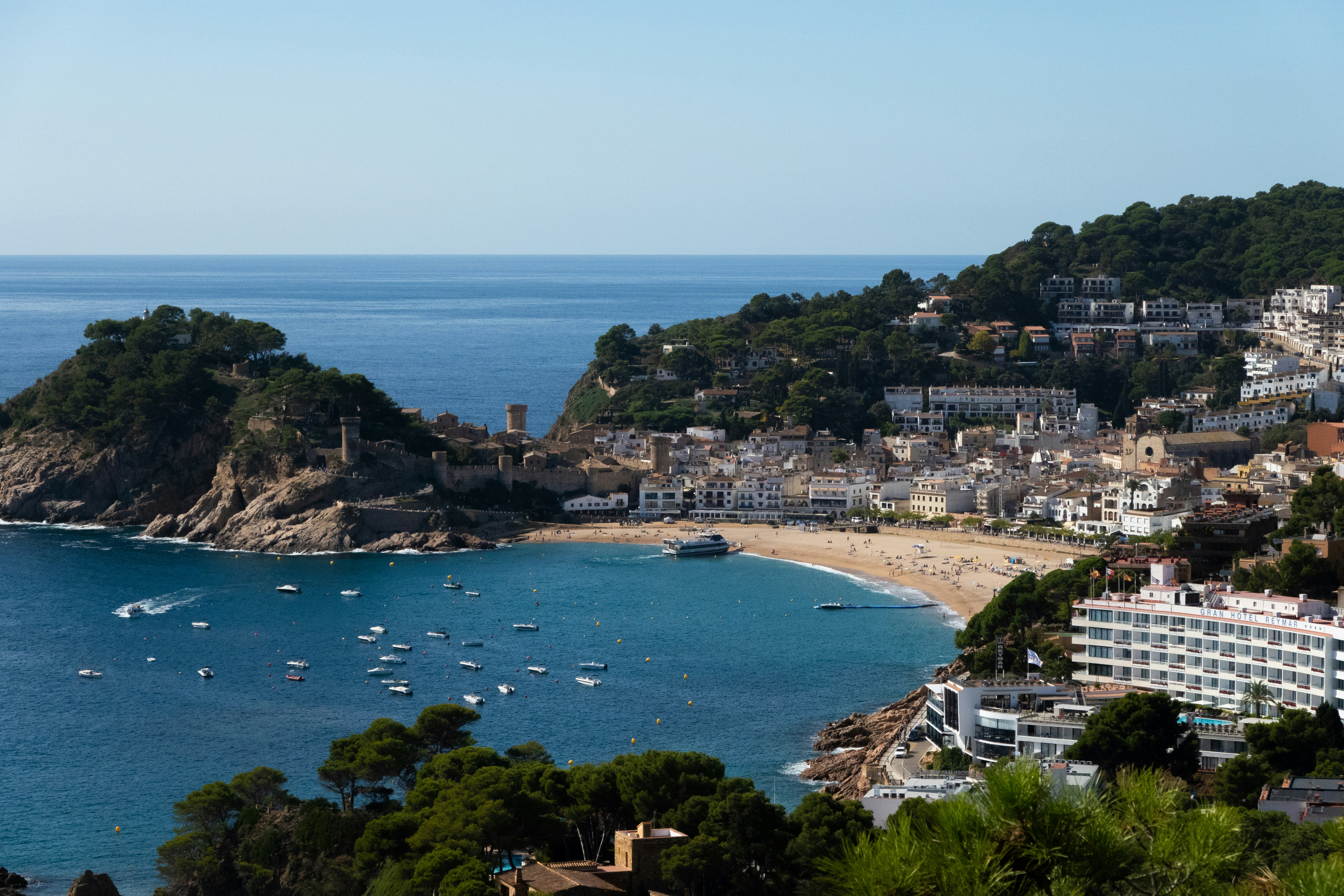 Coastal town with beach and boats in the bay