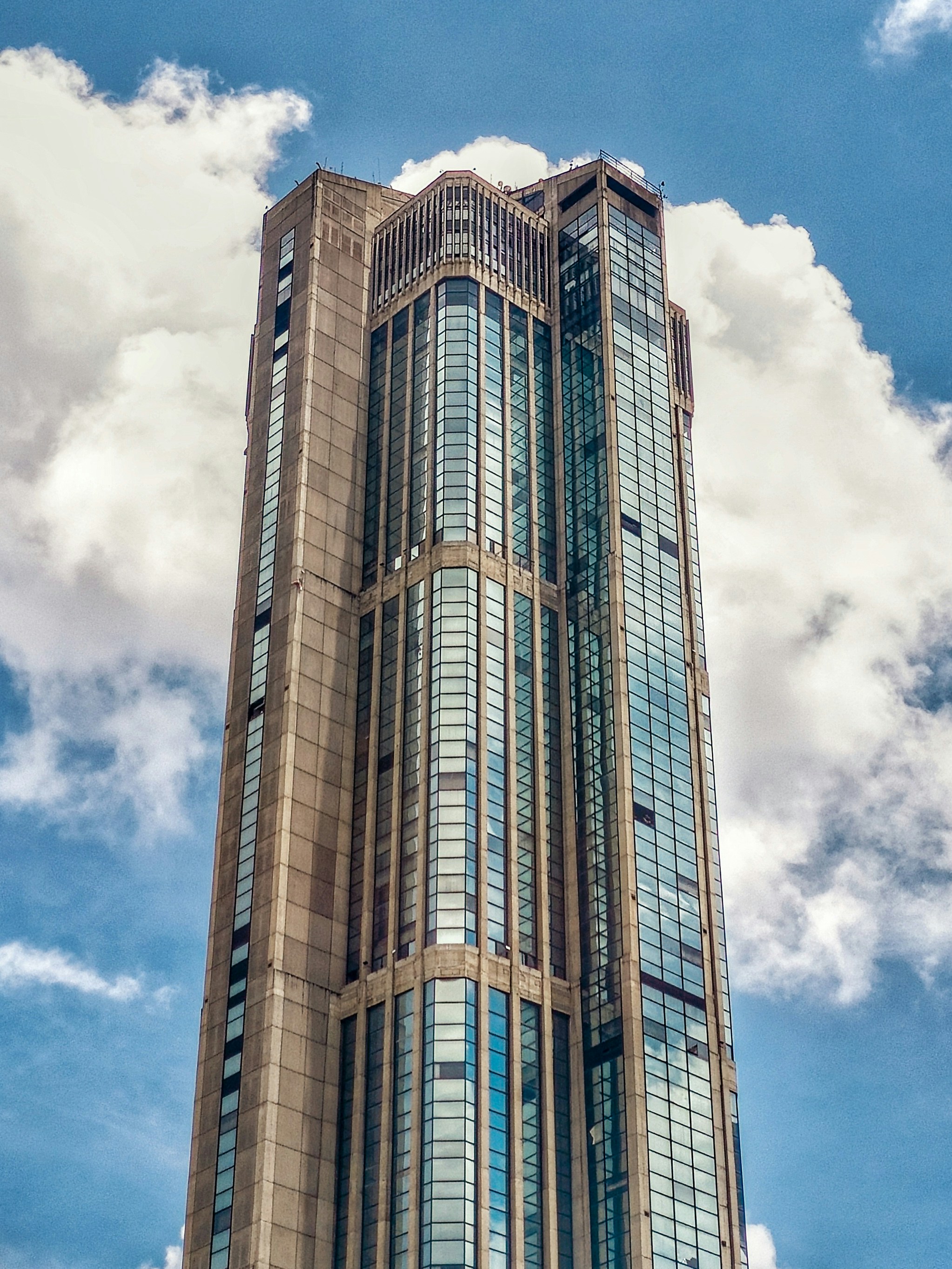Torre de Parque Central, Caracas. | Modern skyscraper against a cloudy blue sky