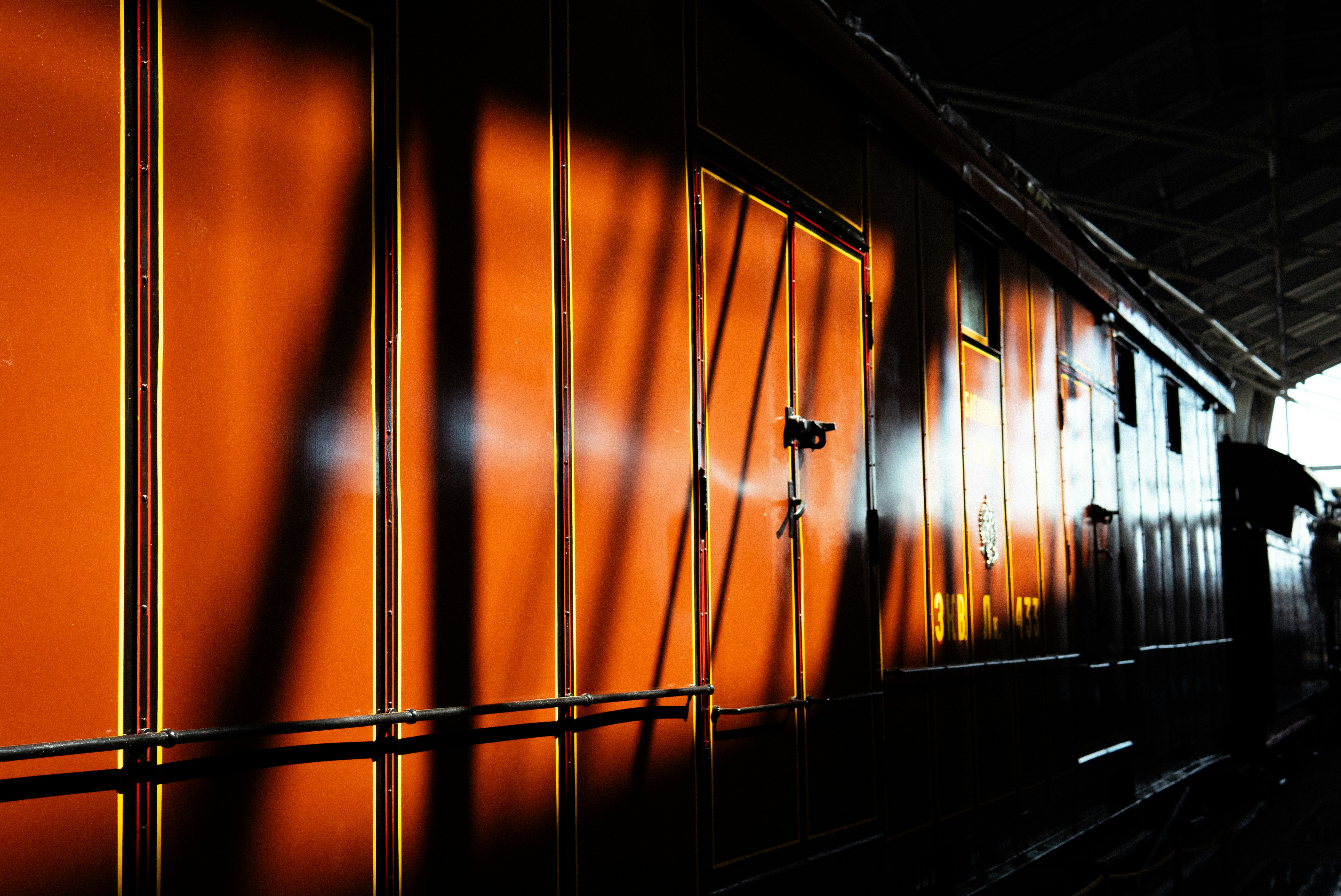 Orange train car with sunlight shadows