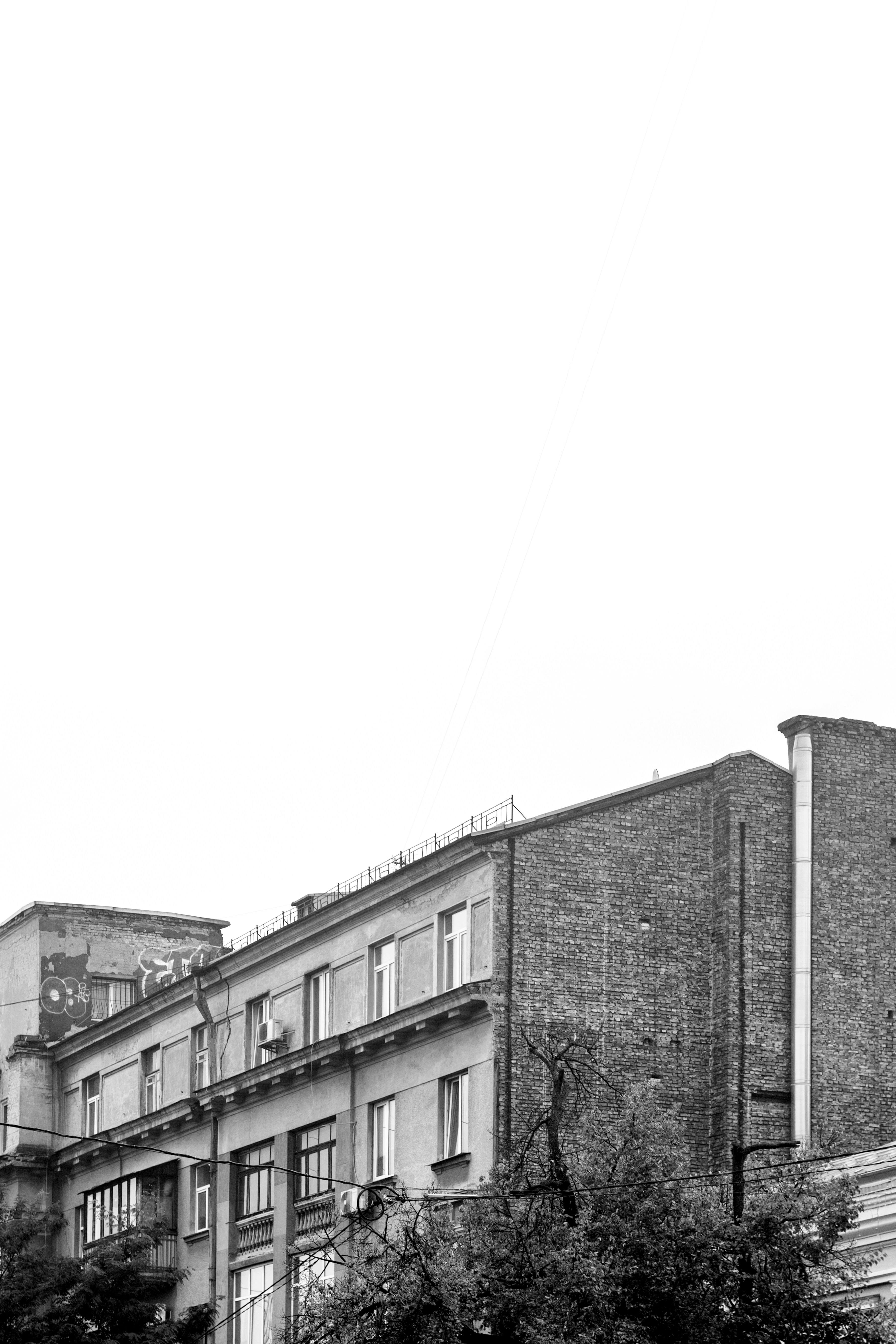 Old brick buildings against a white sky