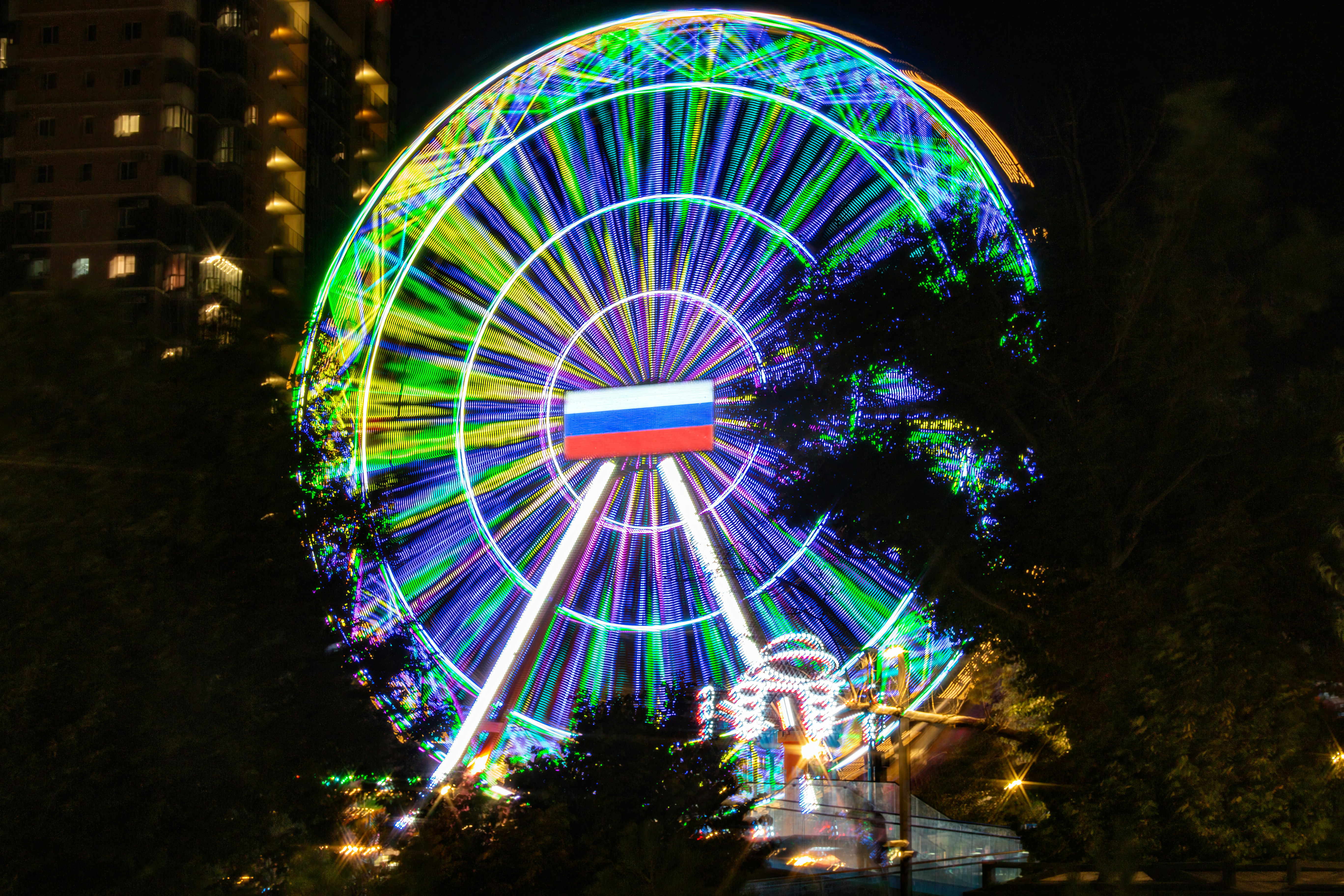 Illuminated Whirl of Color: A Ferris Wheel's Night Dance