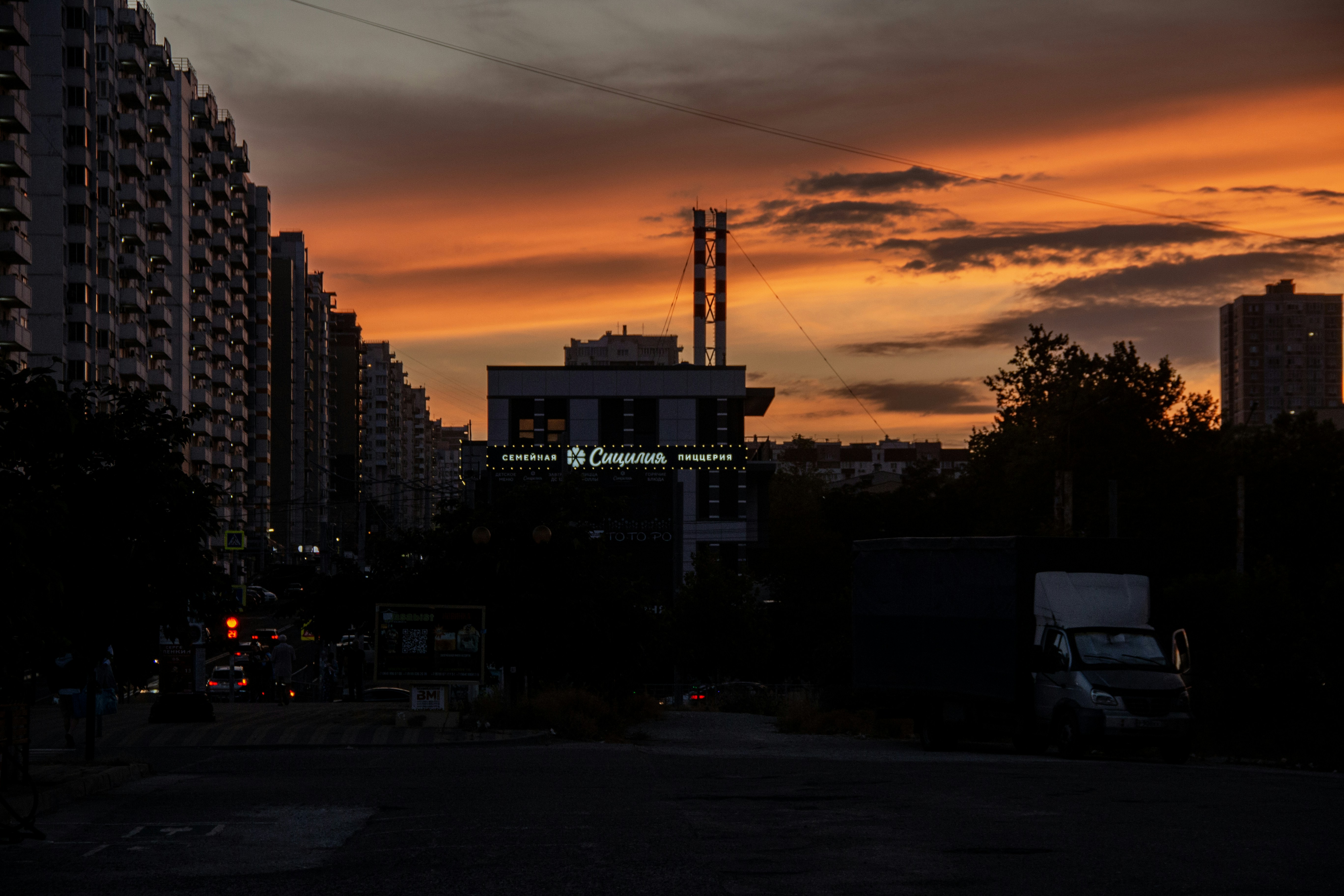 Vibrant sunset over a city skyline at dusk.