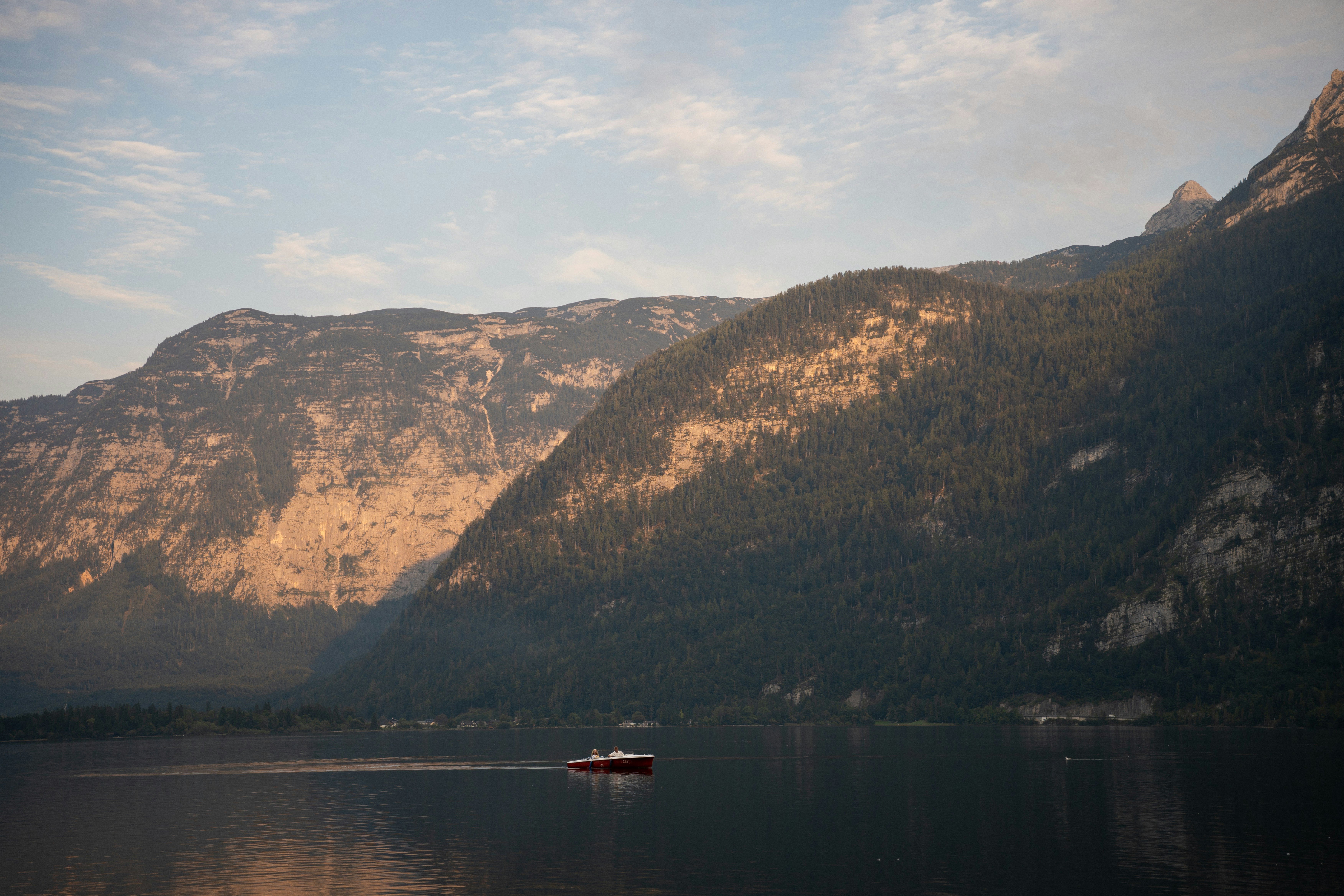 Serenity on the Water: A Vessel's Journey Through Majestic Mountains