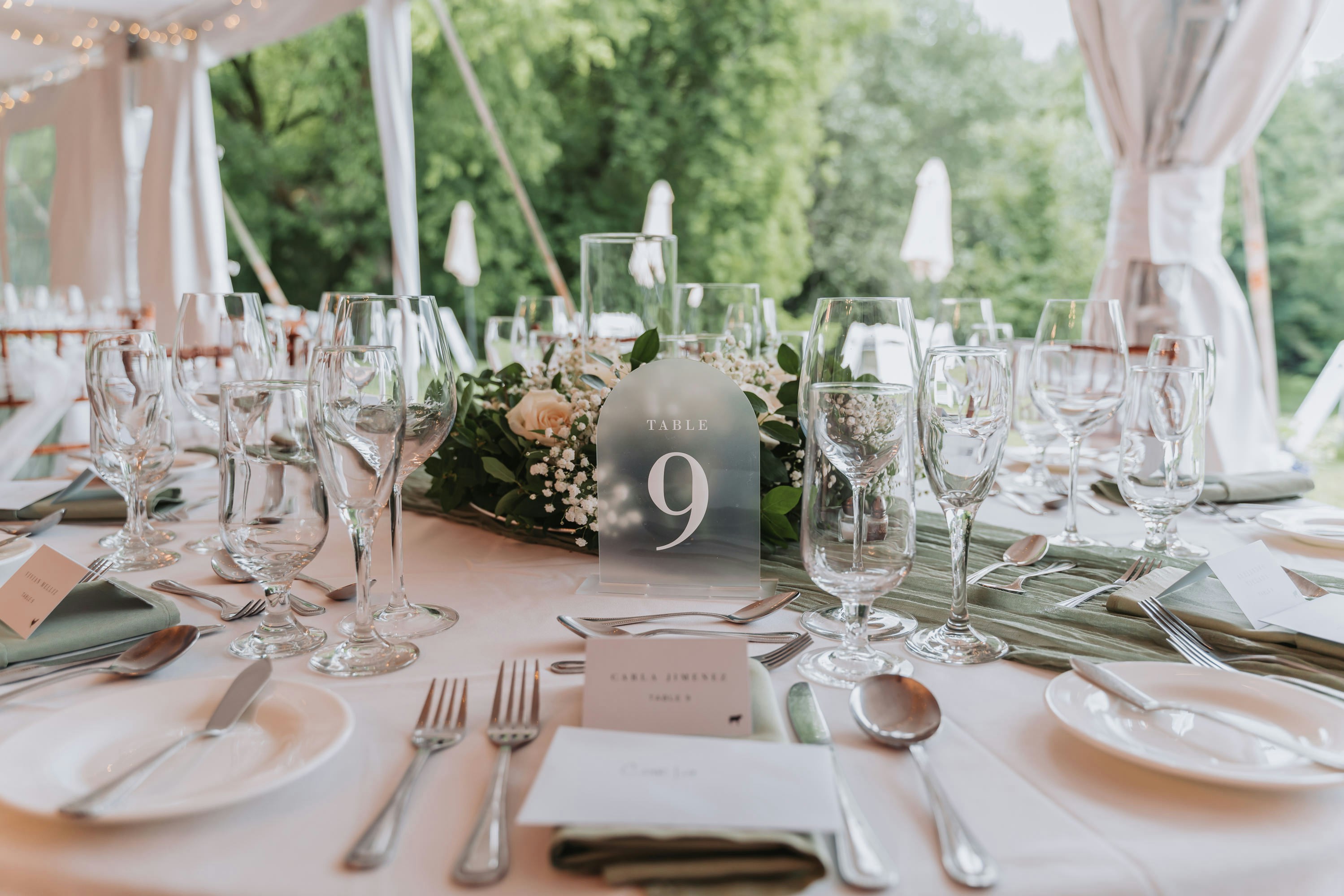 A beautifully set wedding reception table with number nine.