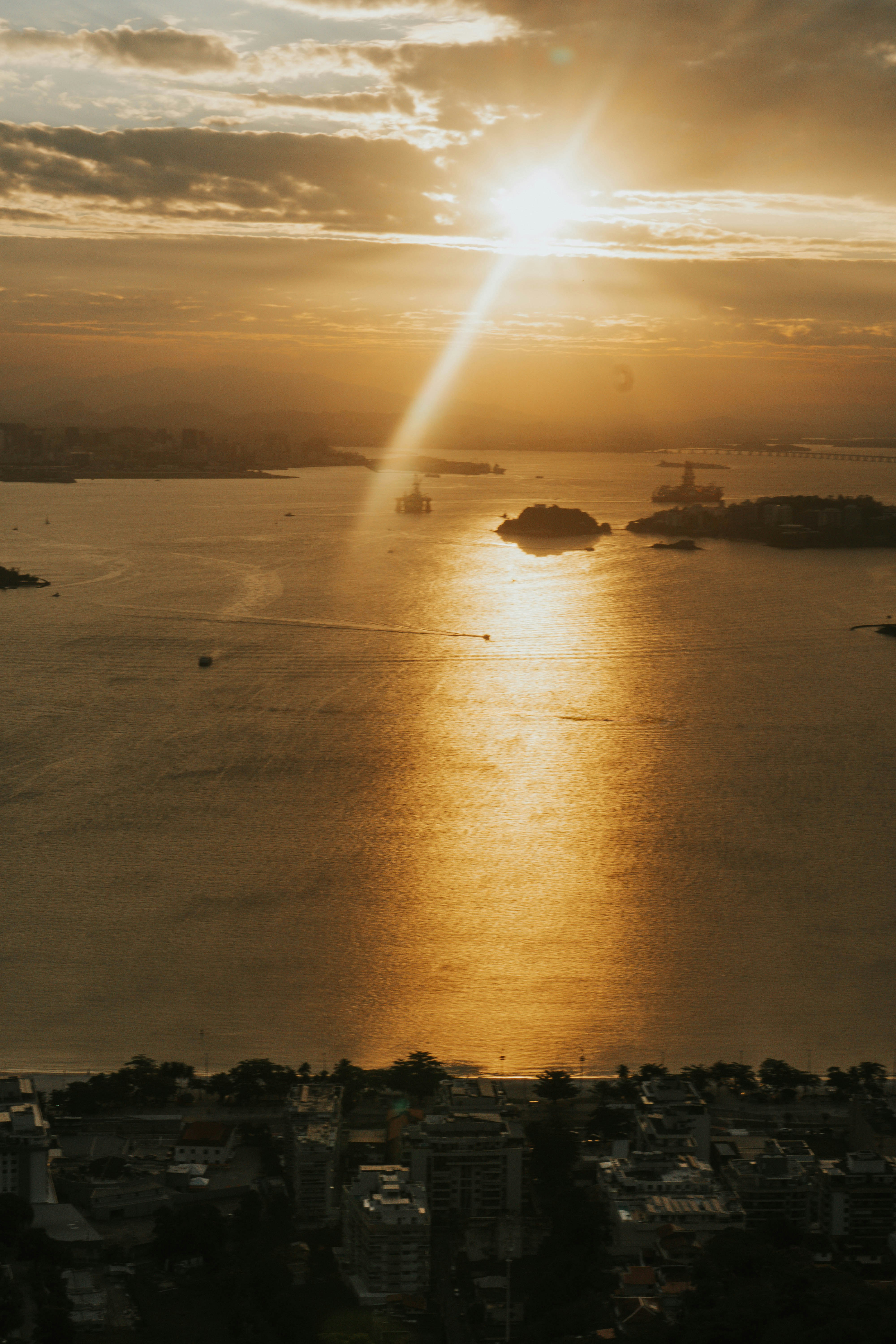 Golden Arc Over the Harbor: Dusk Light Crossing a City Skyline