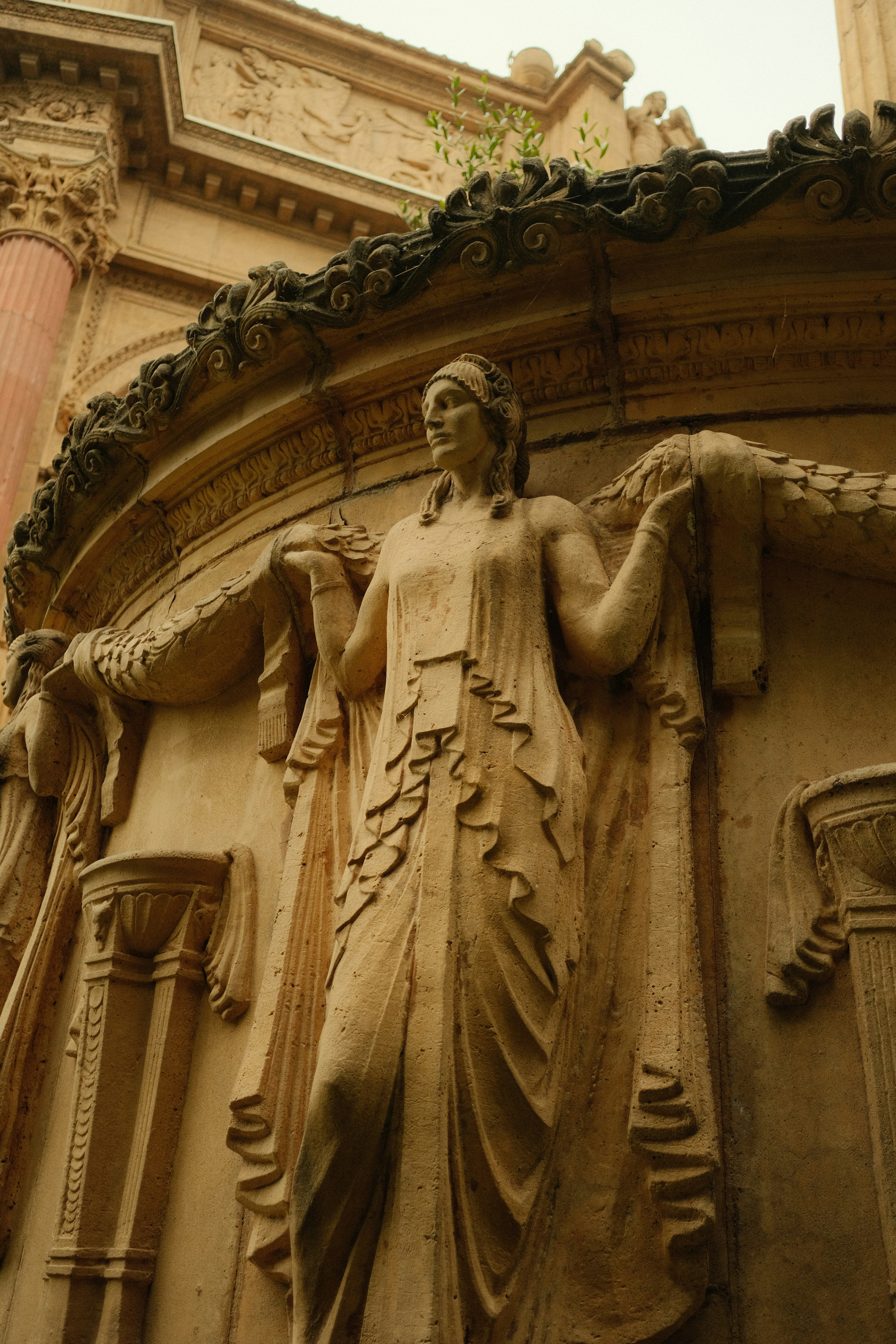 Sepia Quiet: A Stone Angel Framed by Carved Archways