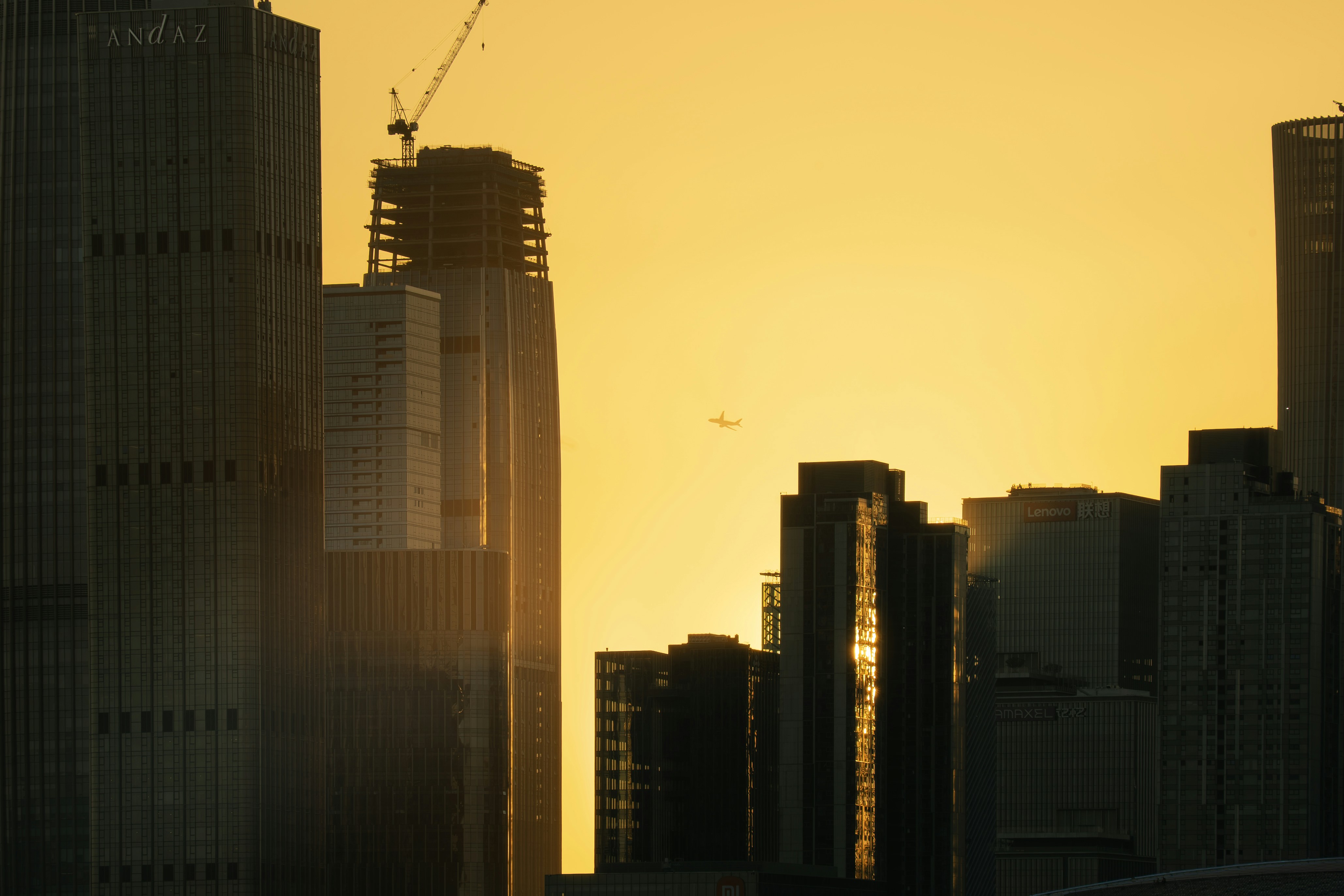 City skyscrapers silhouetted against a golden sunset.