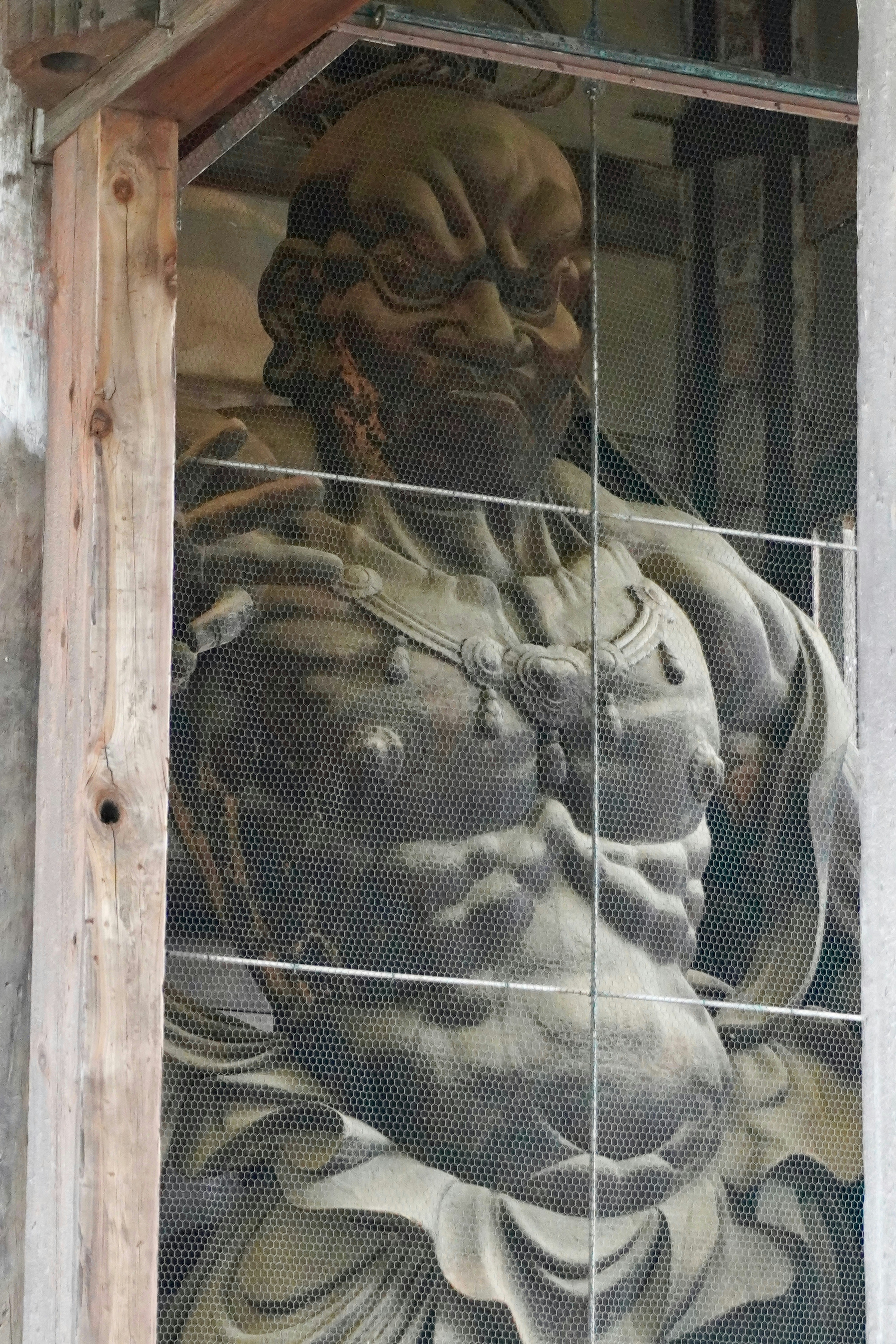 A stone statue of a muscular, fierce-looking deity. photo – Free Japan ...
