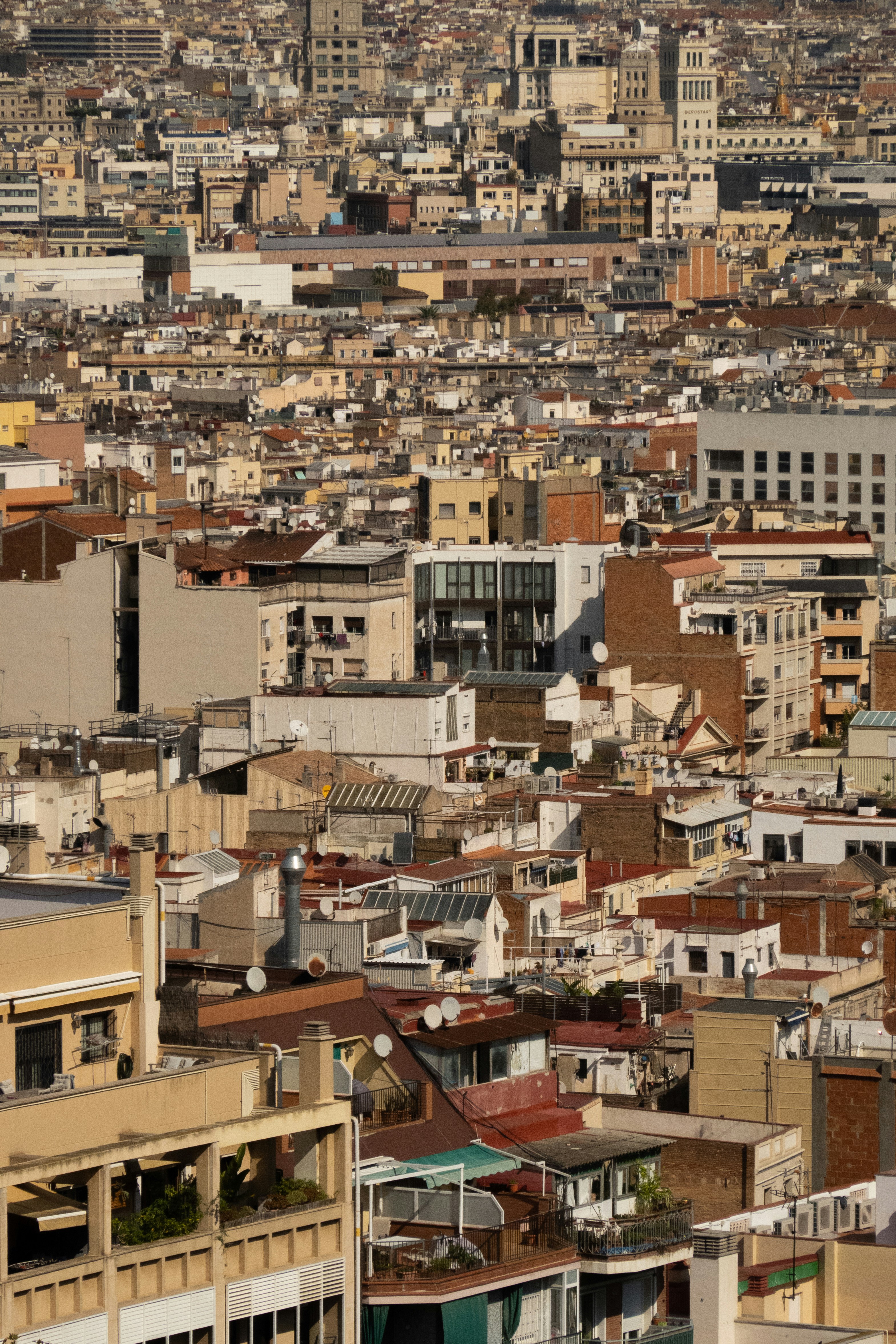 Dense cityscape with many buildings under sunlight