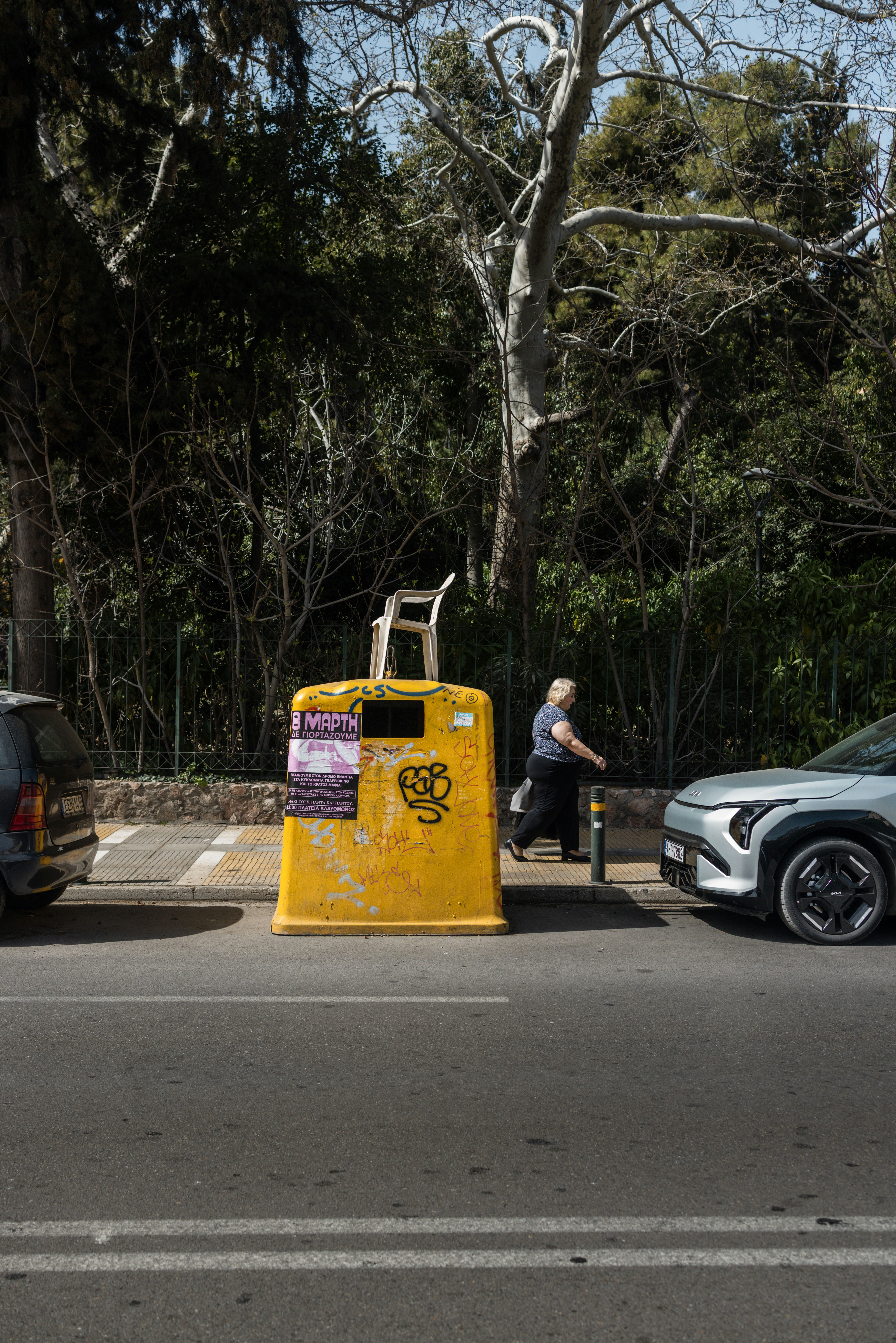 Urban Contrast: A Chair on a Trash Bin