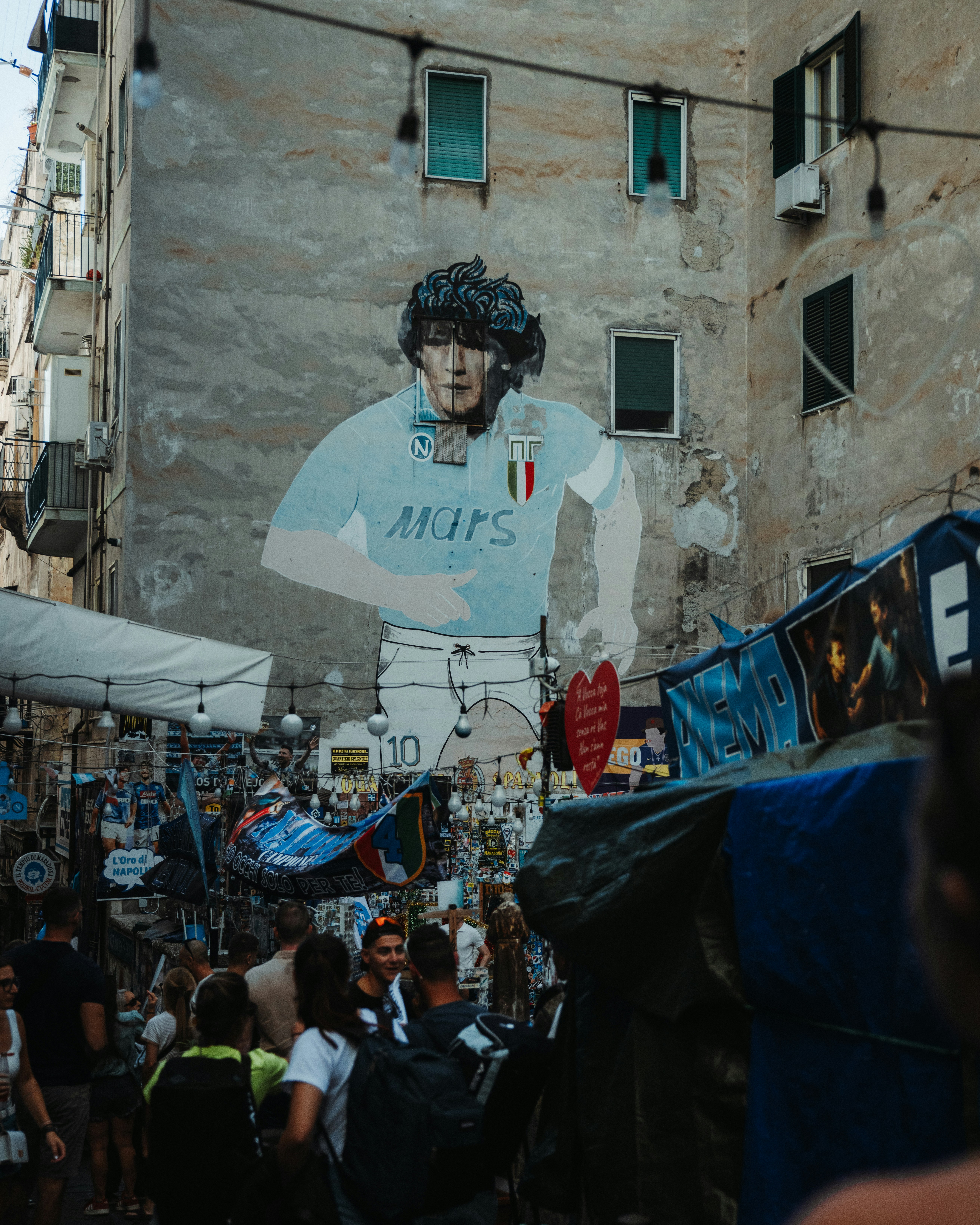 Giant Mars Mural Looms Over a Bustling Street Market