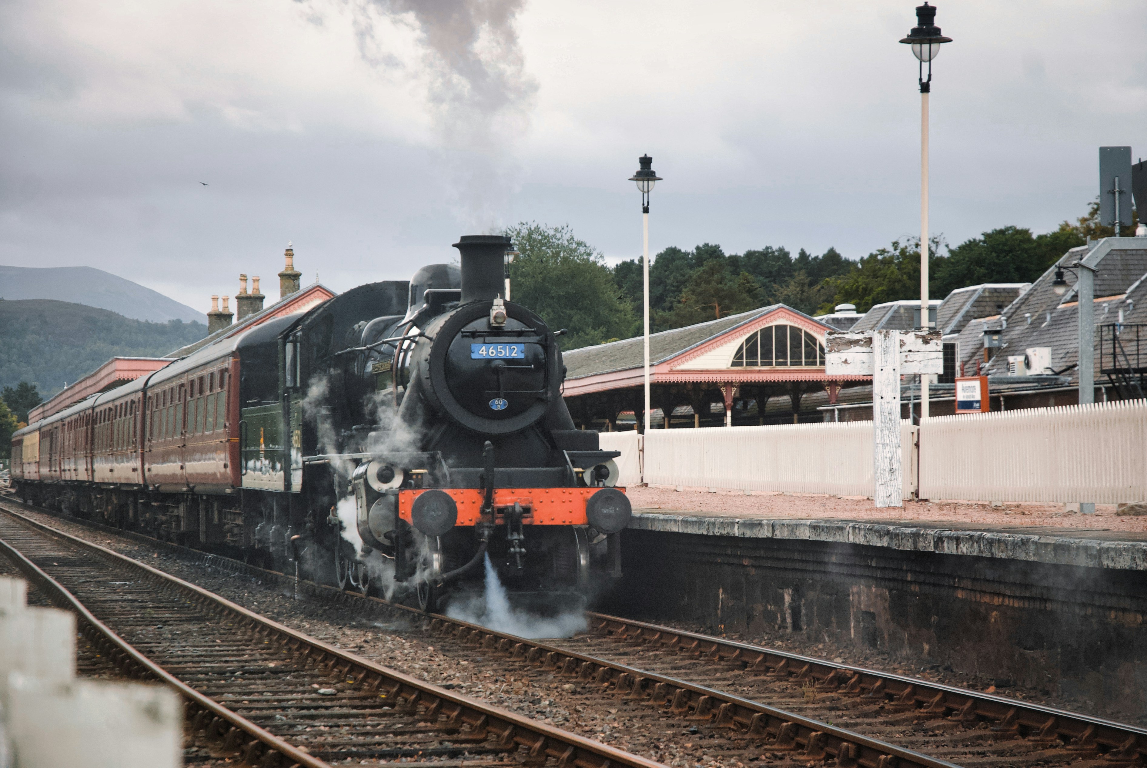Steam train arriving at a station platform