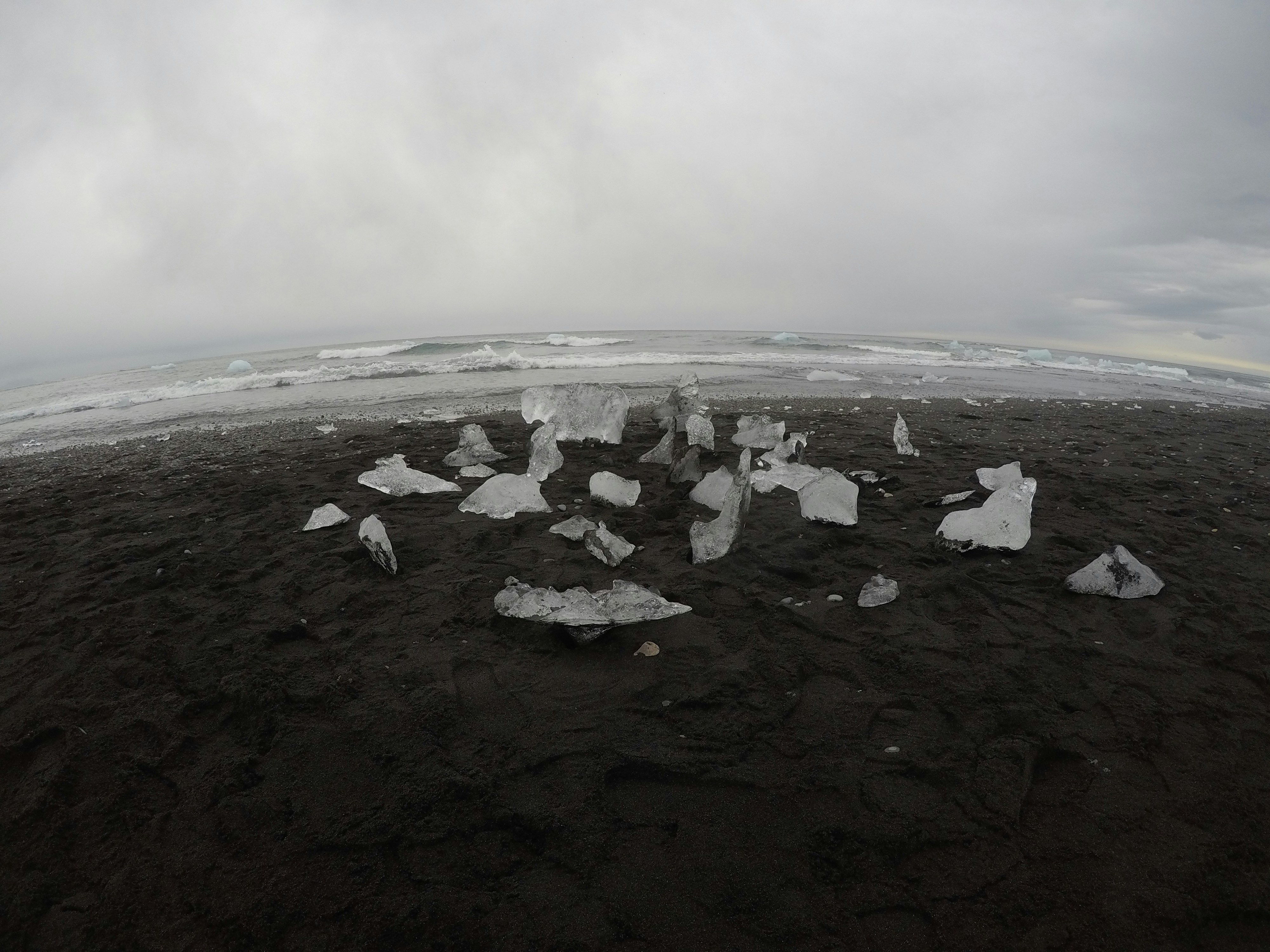 Fragments of Ice on a Dark Shoreline