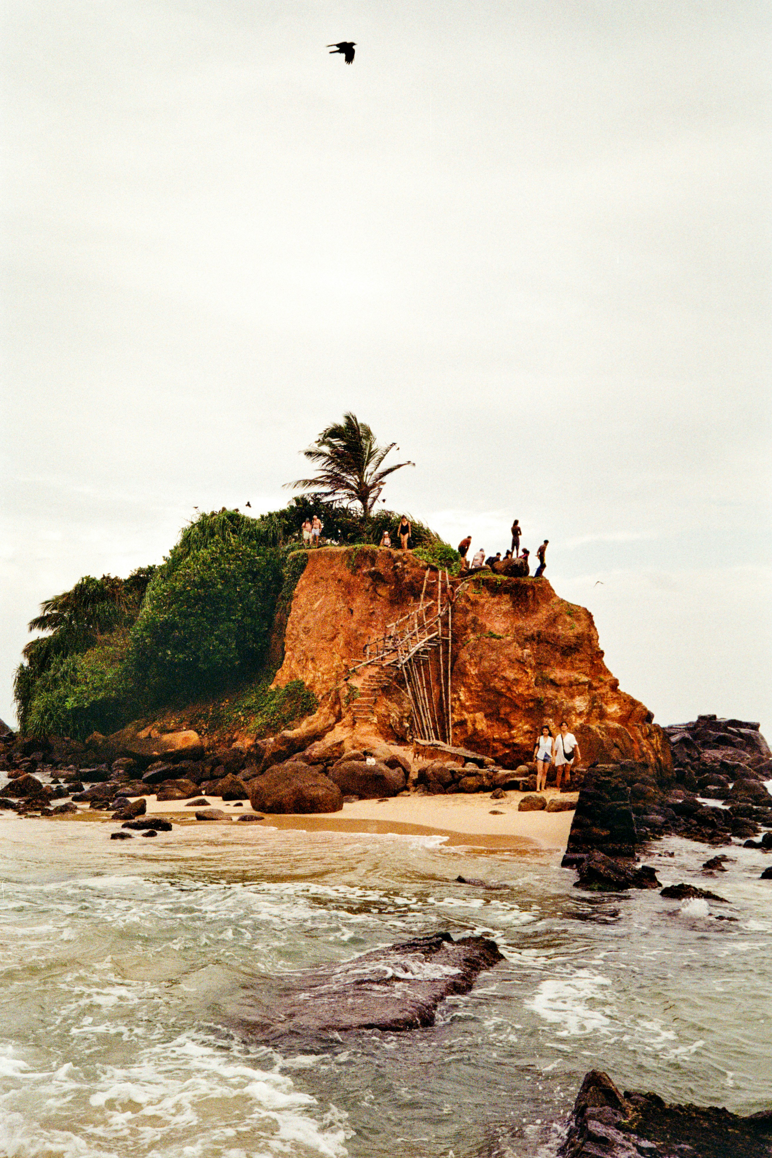 Kodak Gold 200 🎞️ | People on a rocky island with a wooden staircase.