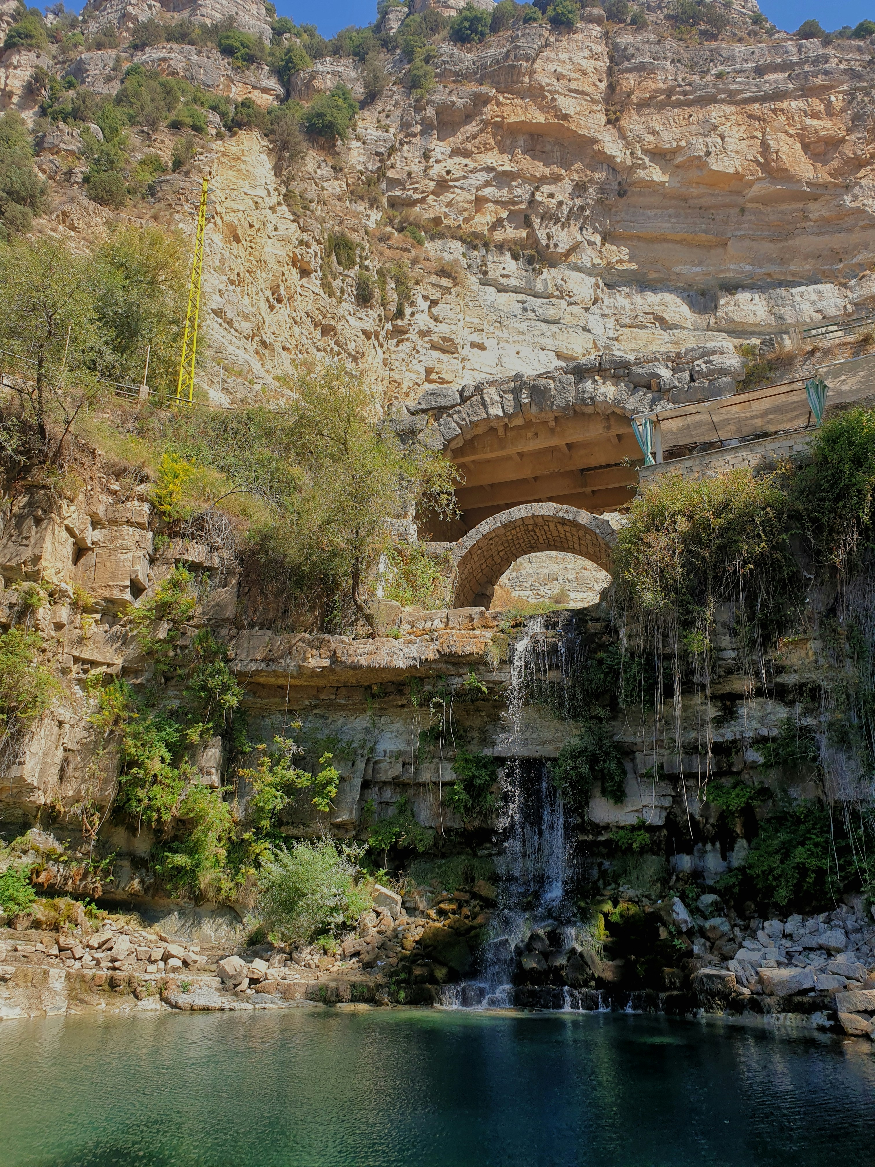 Waterfall cascading down rocky cliffs into a pool