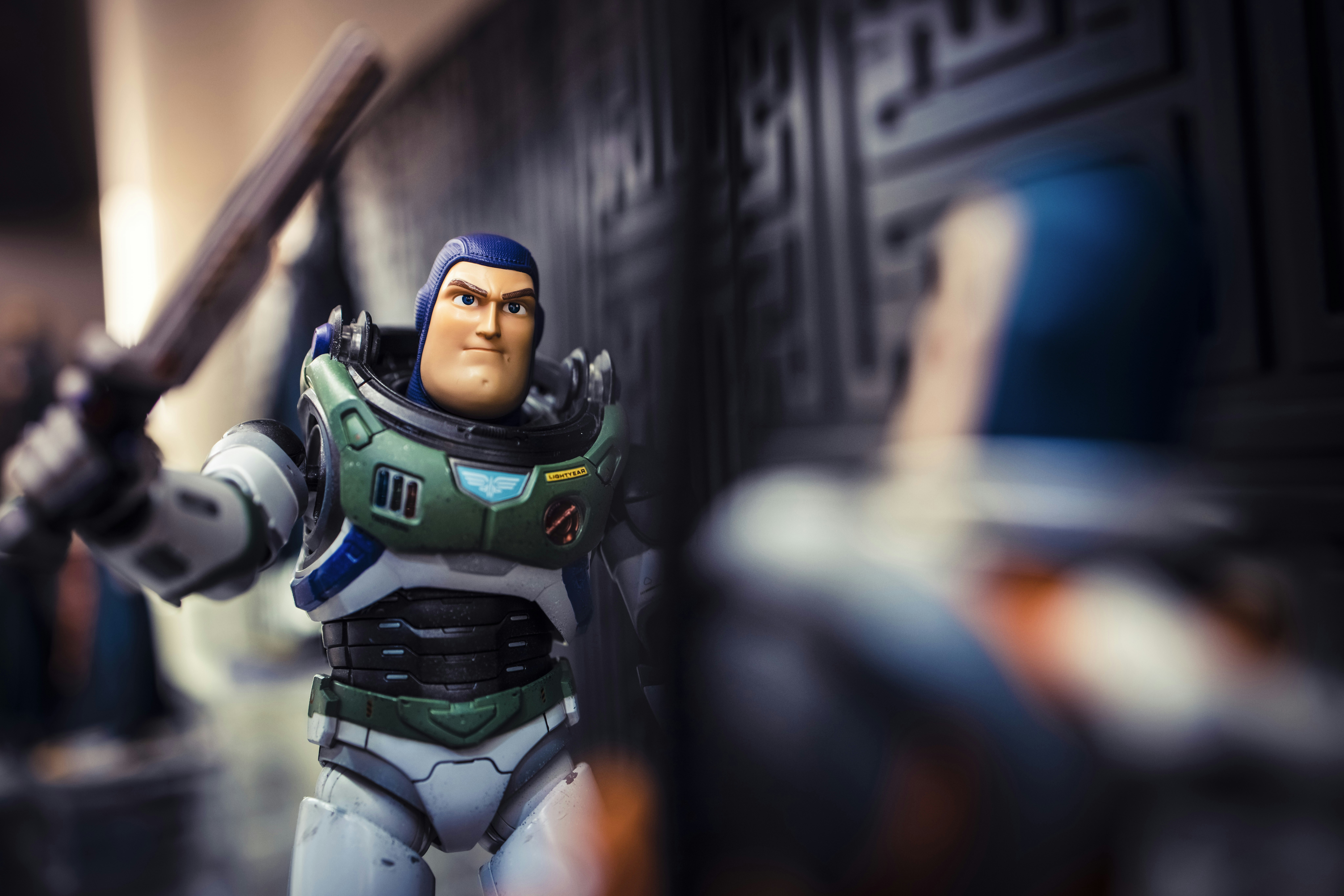 Buzz lightyear toy holding a sword, facing another figure. photo – Free ...