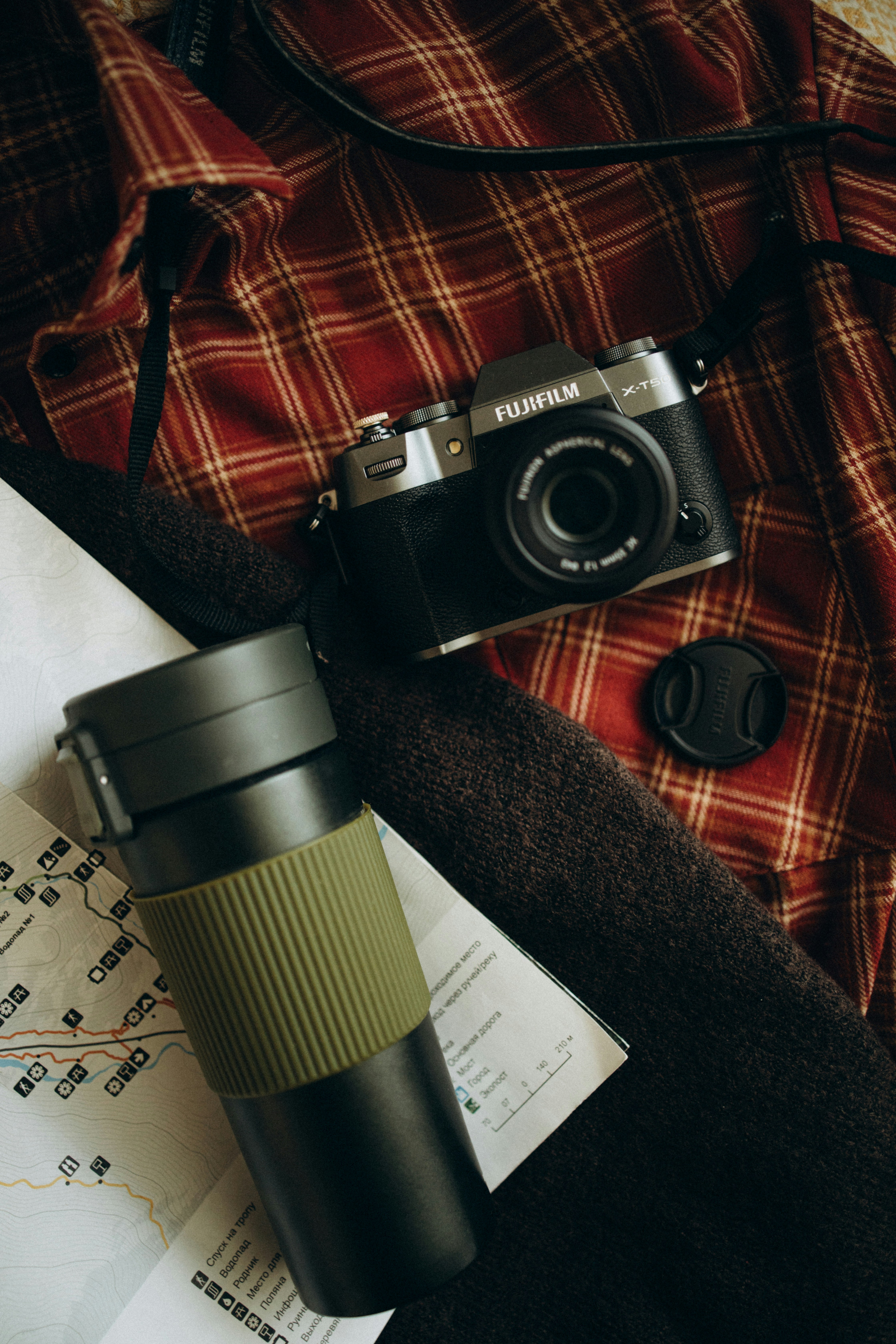 Camera, thermos, and map for travel adventure