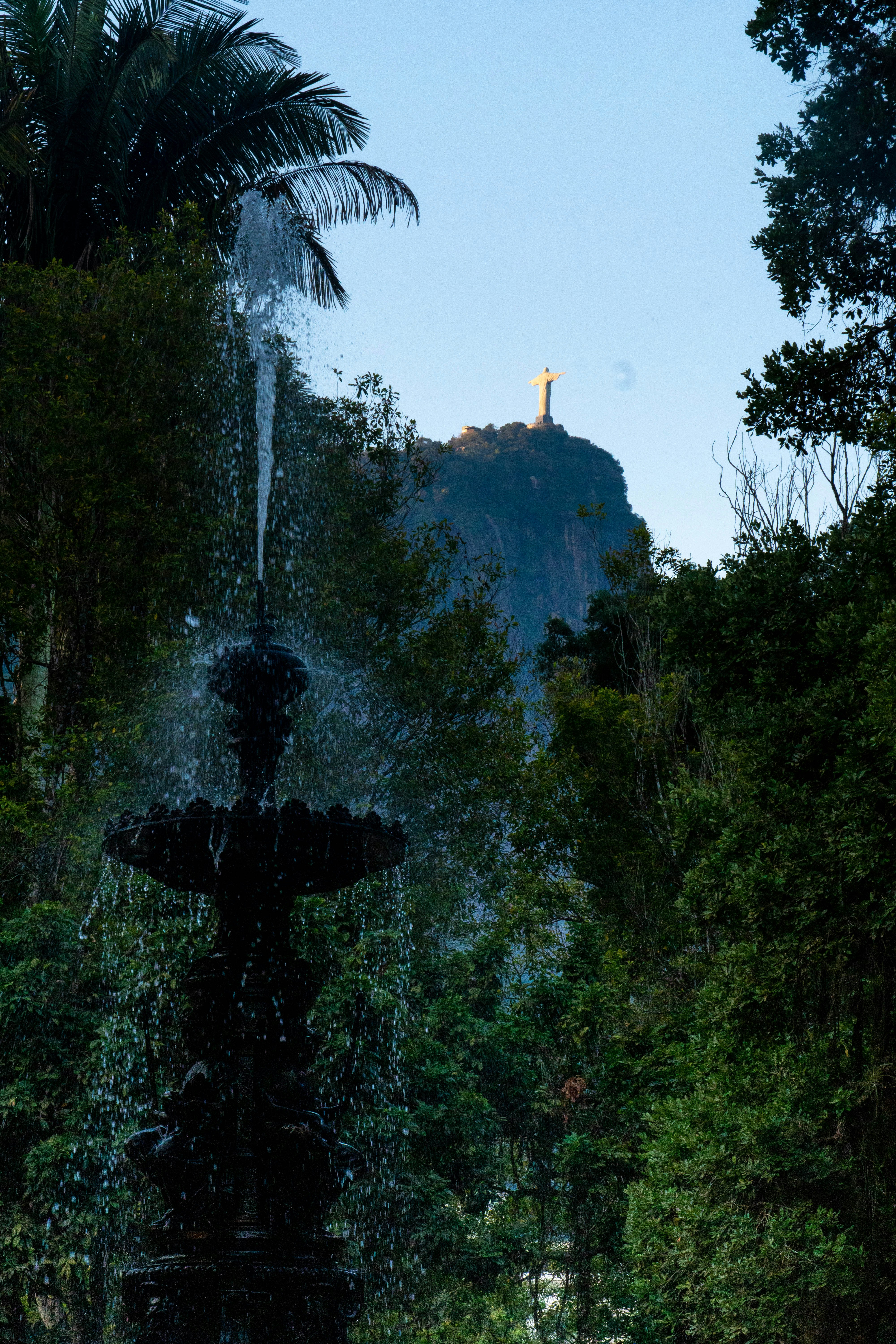 Hilltop Sentinel: Christ the Redeemer over a fountain-fringed garden