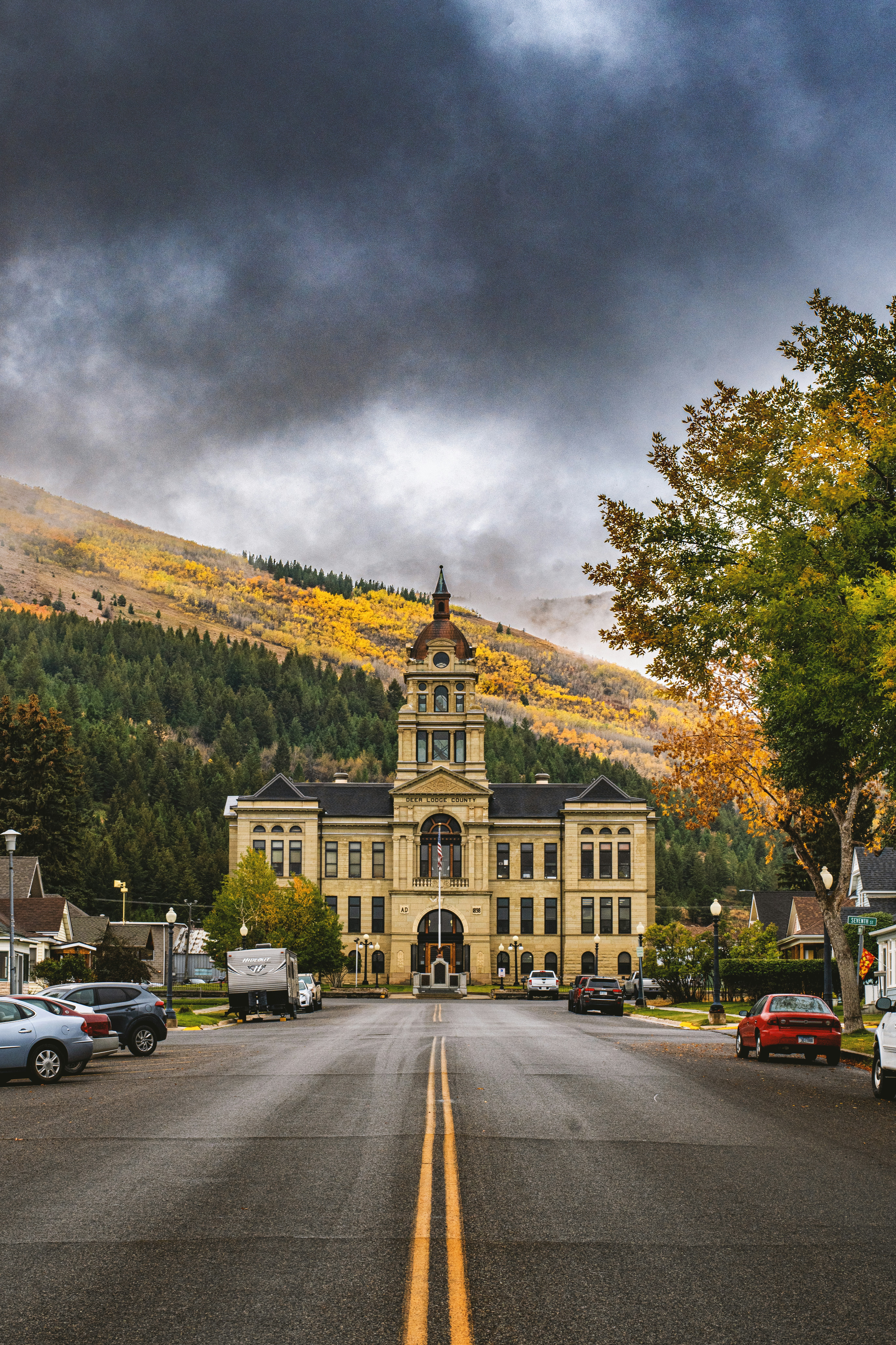 Historic courthouse with autumn trees and cloudy sky