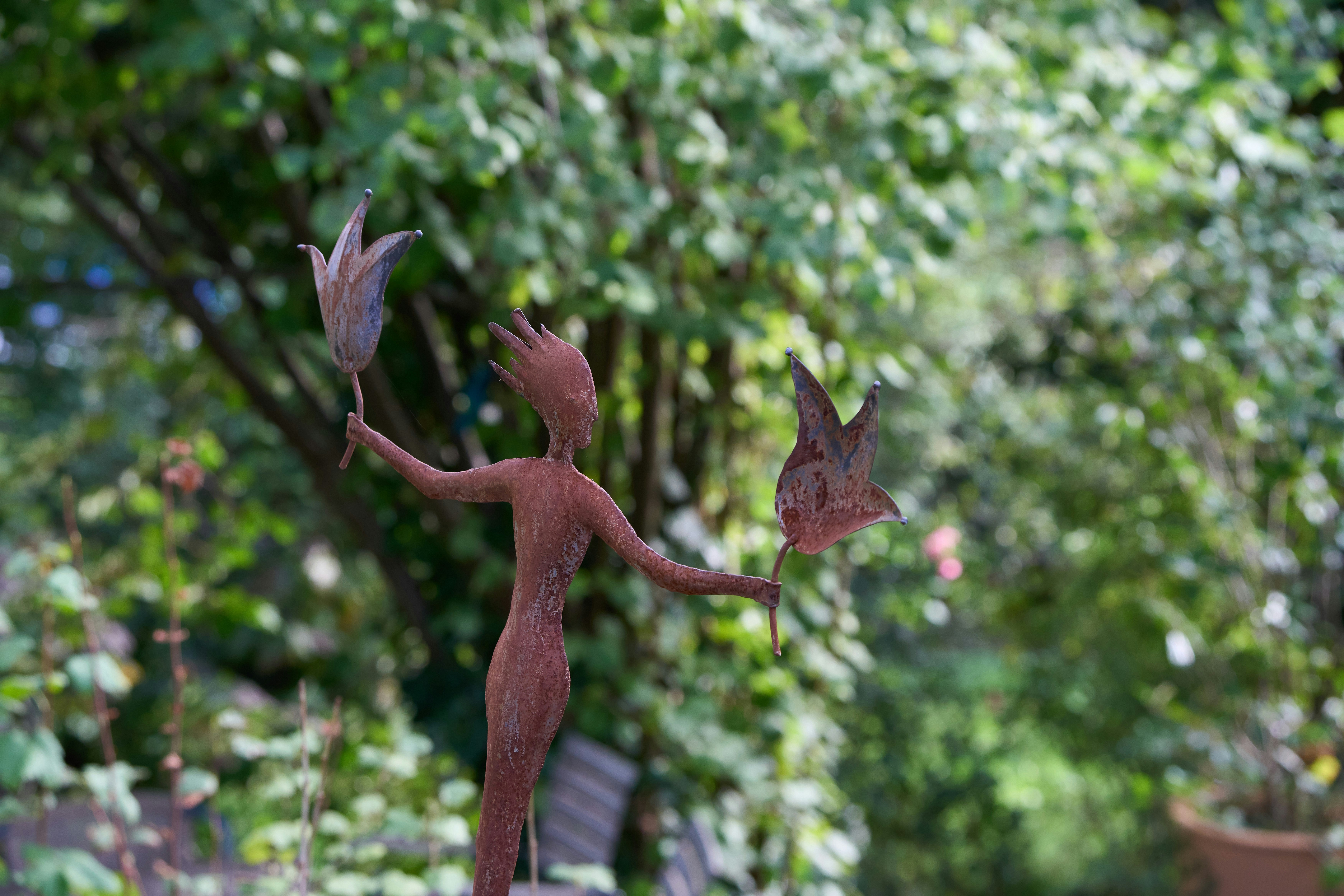 Whispers of Nature: A Metal Dancer Amidst Greenery